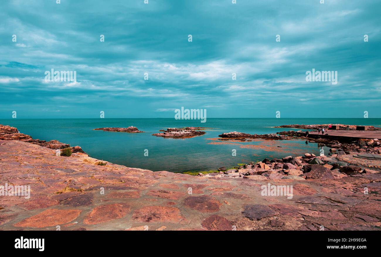 Colorful rock formation in the sea around picturesque small town ...