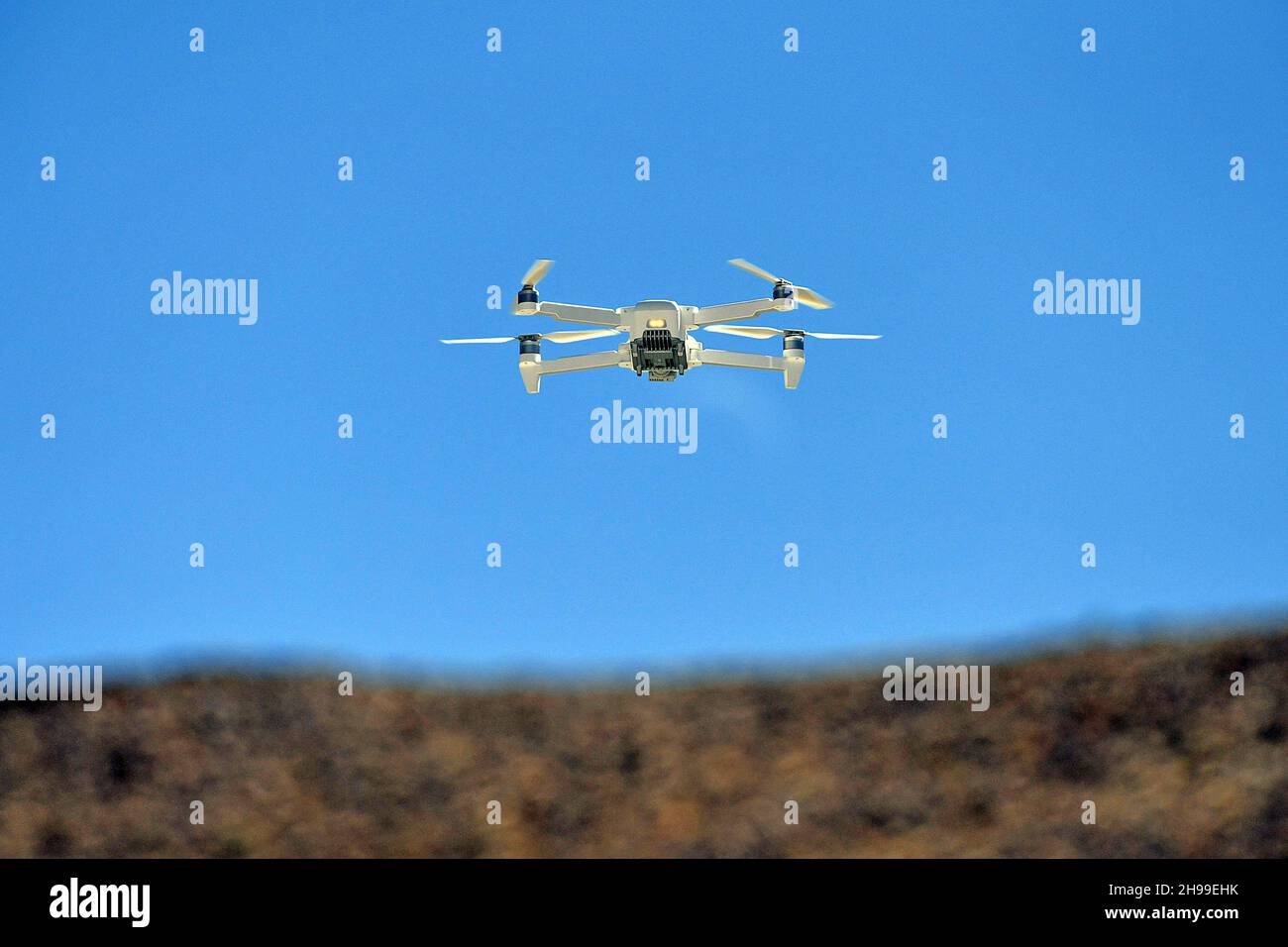 A low angle shot of a drone in motion under the blue skies Stock Photo ...