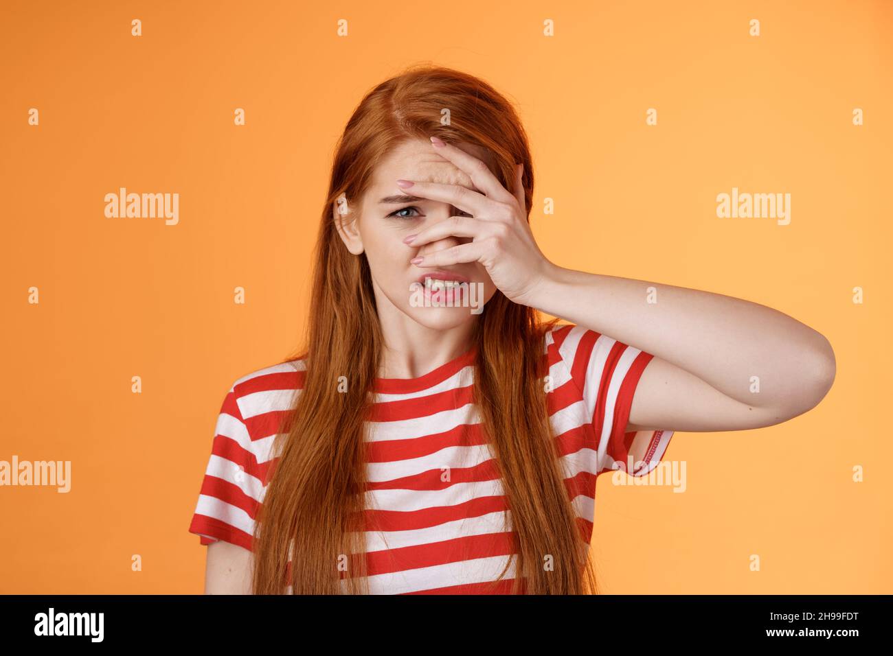 Uneasy redhead girl pity for bad situation, trying not look awful ...