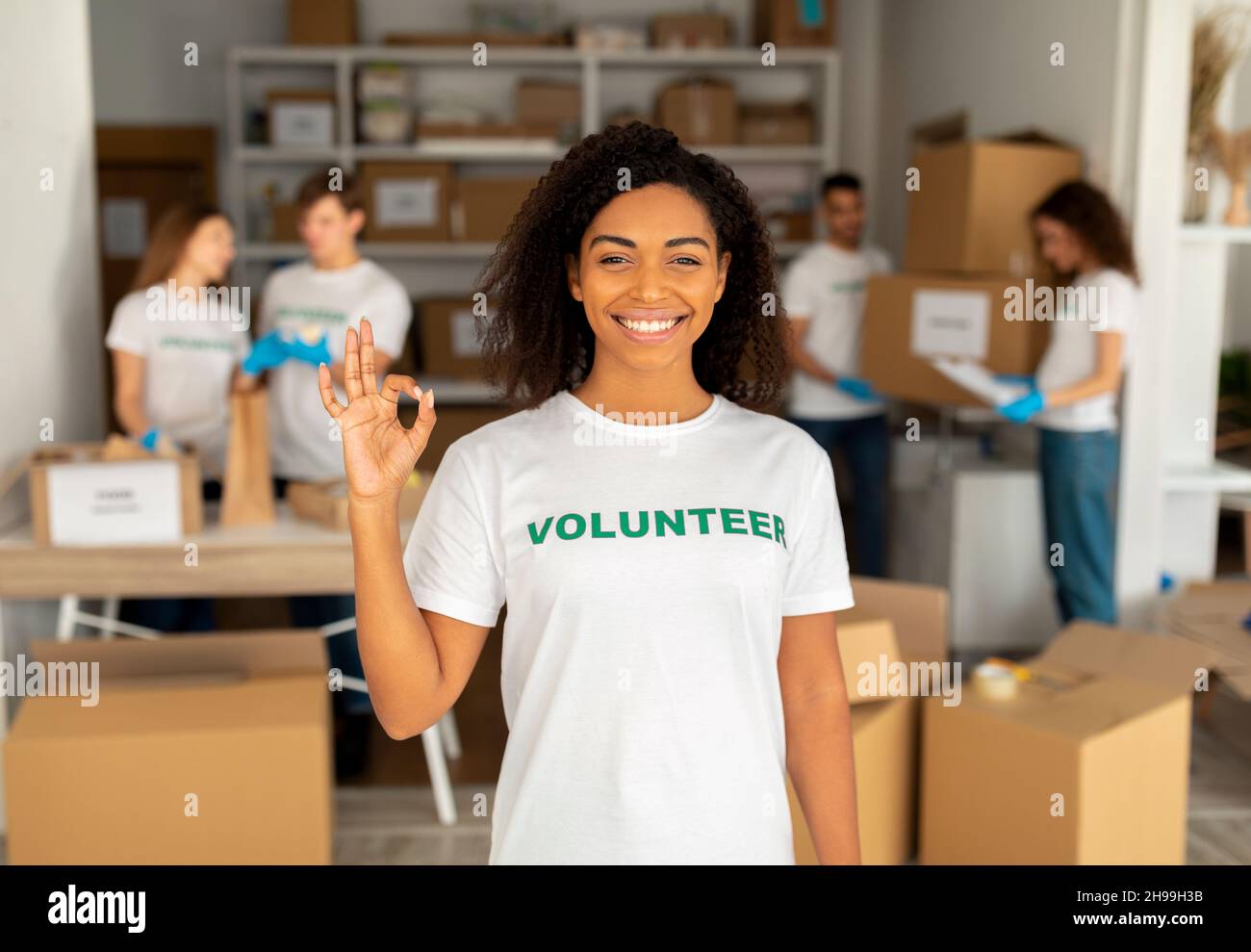 Volunteering concept. Happy african american activist showing OK ...