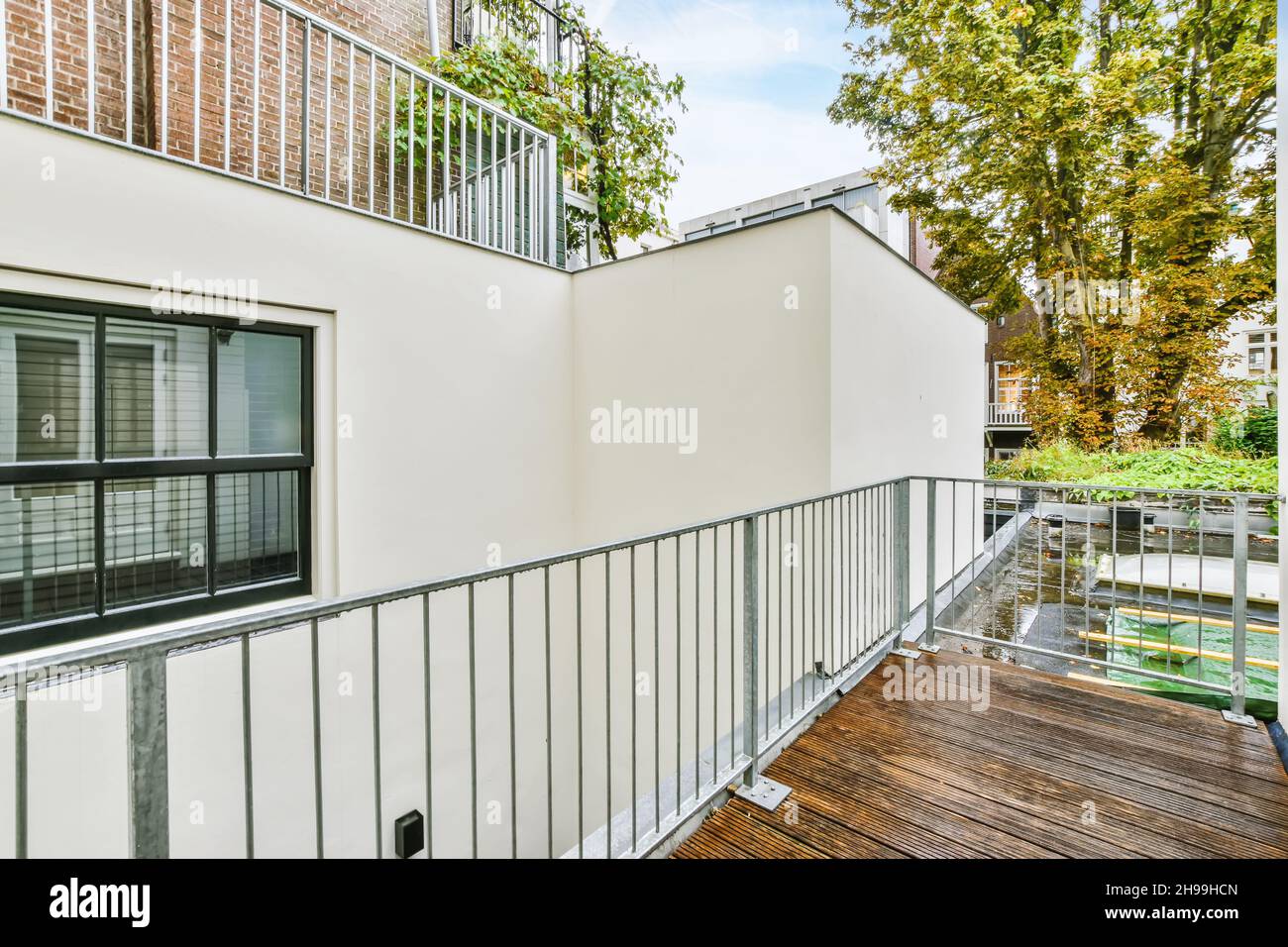 Cozy pretty balcony with comfortable railings and wooden floor Stock ...