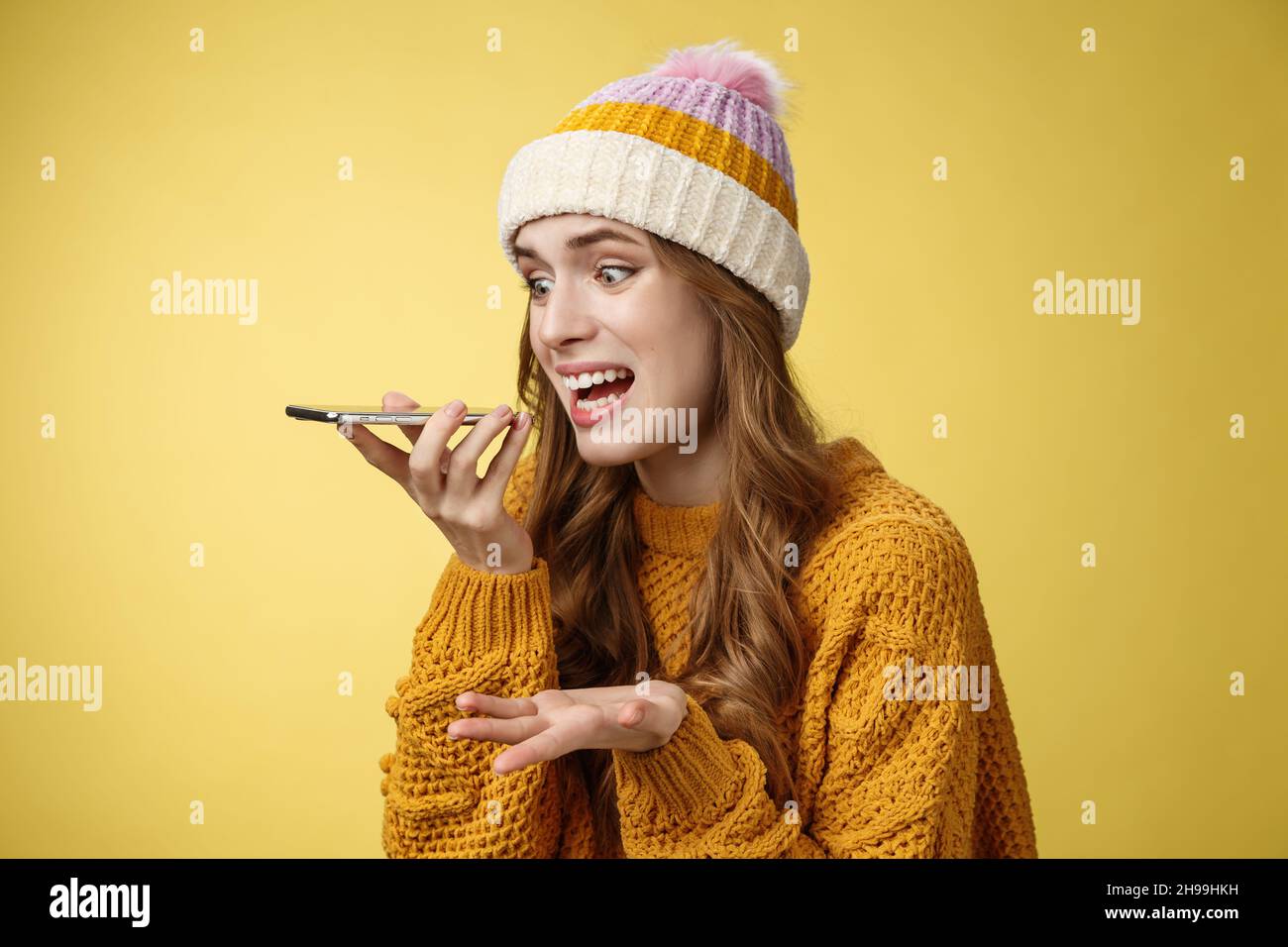 Close-up annoyed angry young woman shouting phone recording audio ...