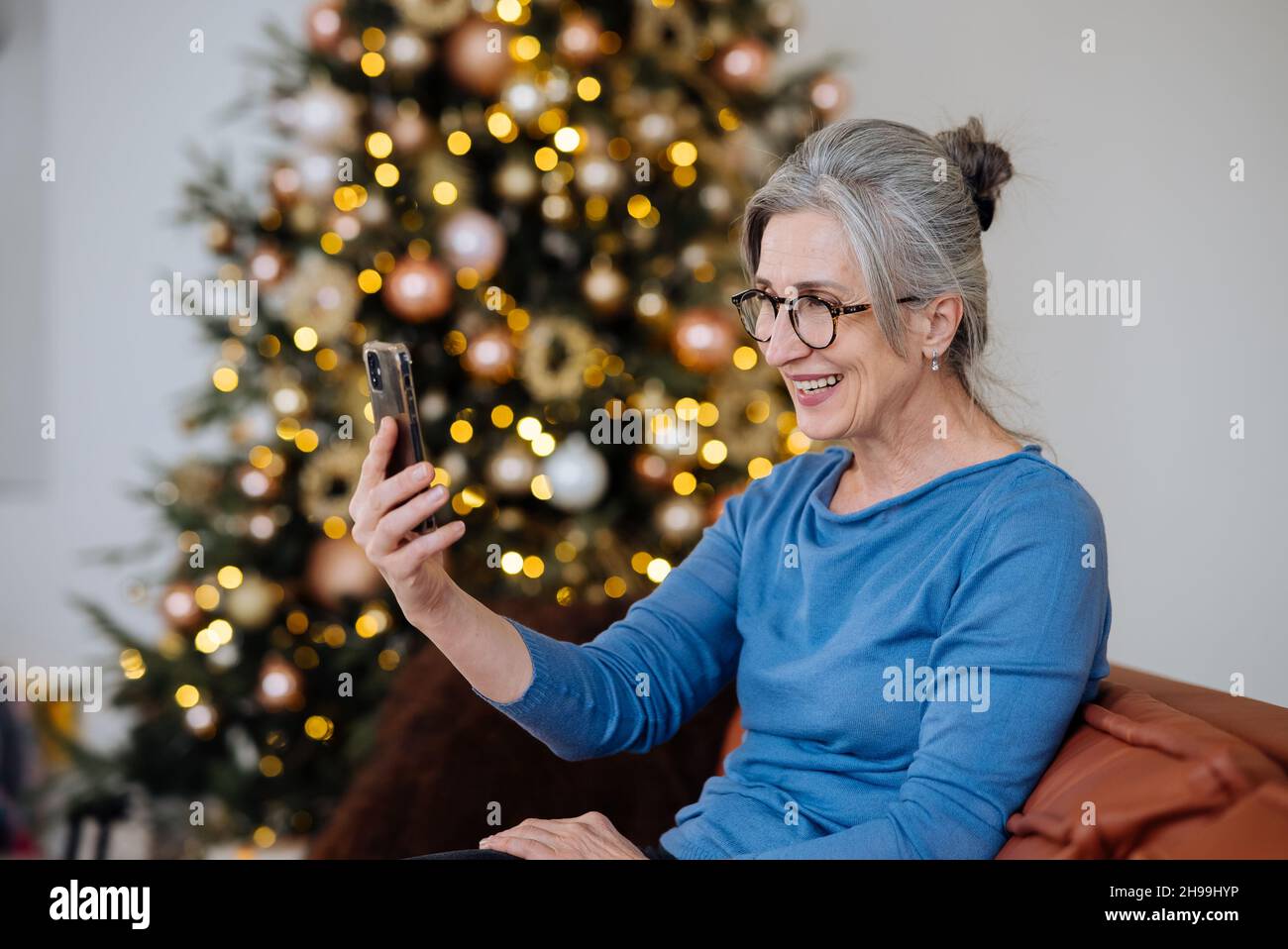 Happy smiley face senior elderly woman using smartphone video call ...