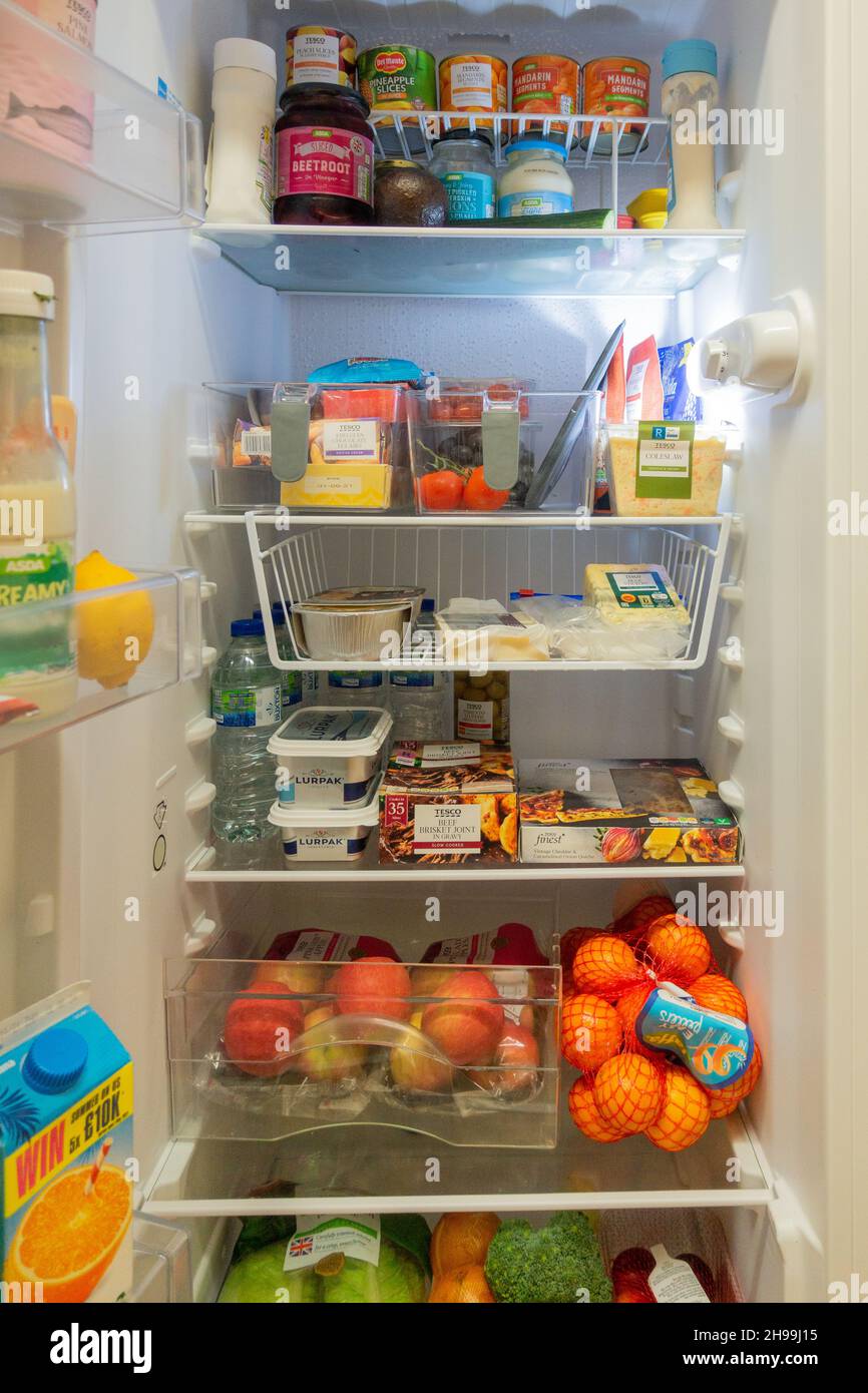 looking into open and very full large fridge, refidgerator Stock Photo ...