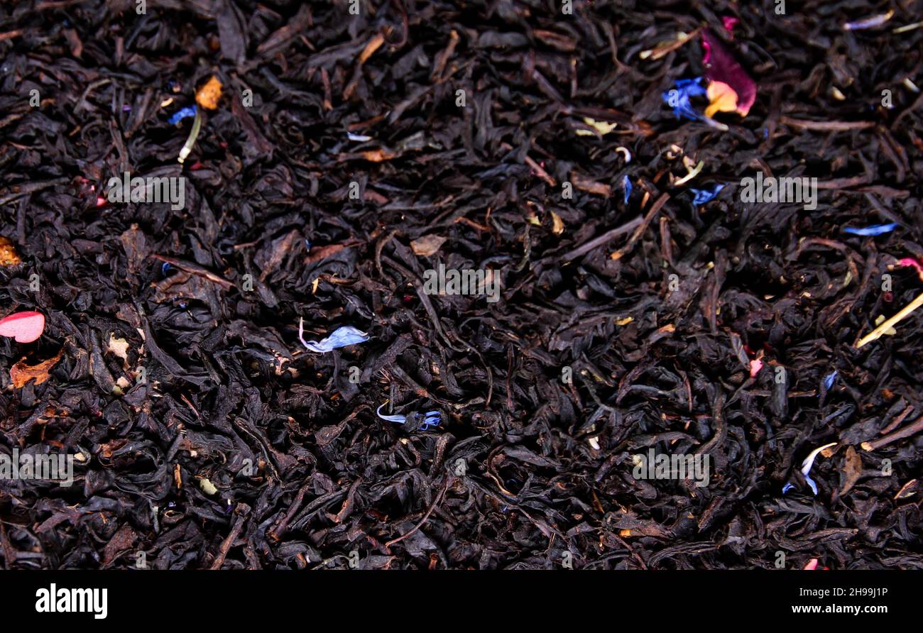 black leaf tea with flower petals close-up, drink Stock Photo - Alamy
