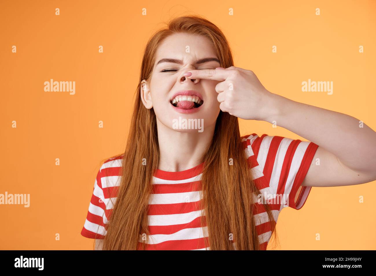 Silly childish redhead girl fool around, make piggy nose, show tongue ...