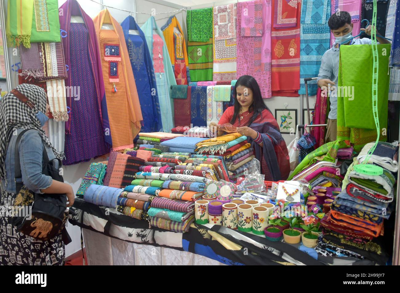 Dhaka. 5th Dec, 2021. Exhibitors arrange products at a stall during ...