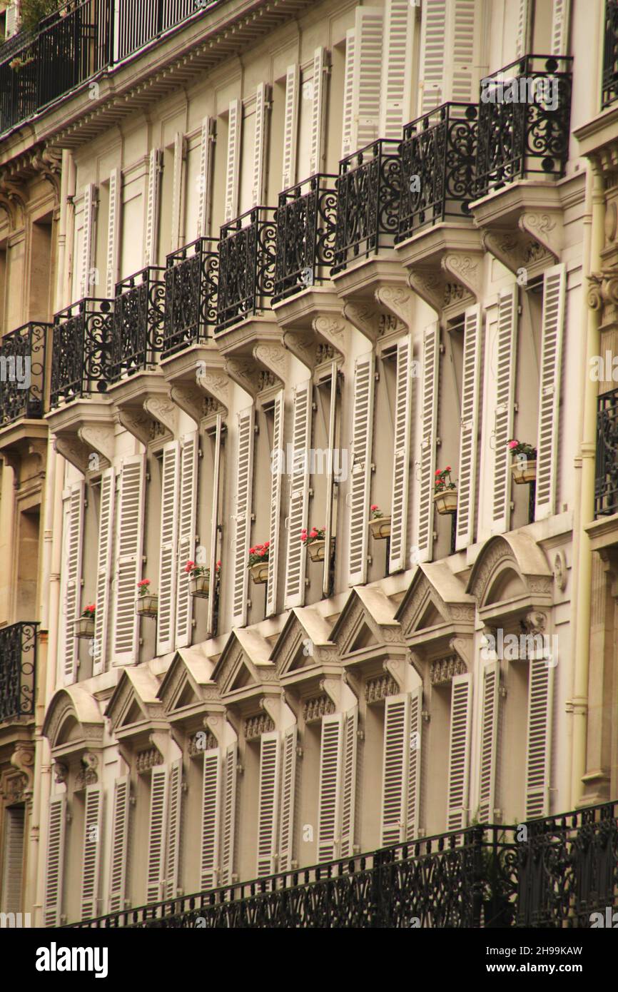 A vertical shot of the exterior of a building with windows in Paris ...