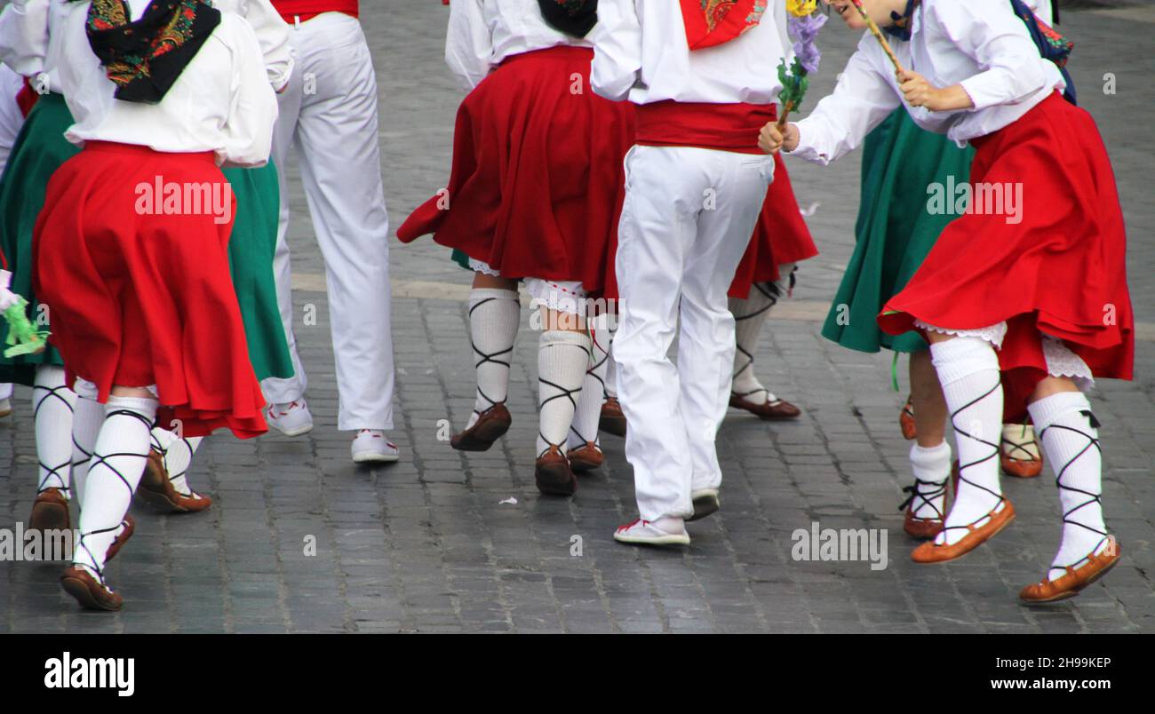 The folk dancers dancing with traditional costumes outside in Basque ...