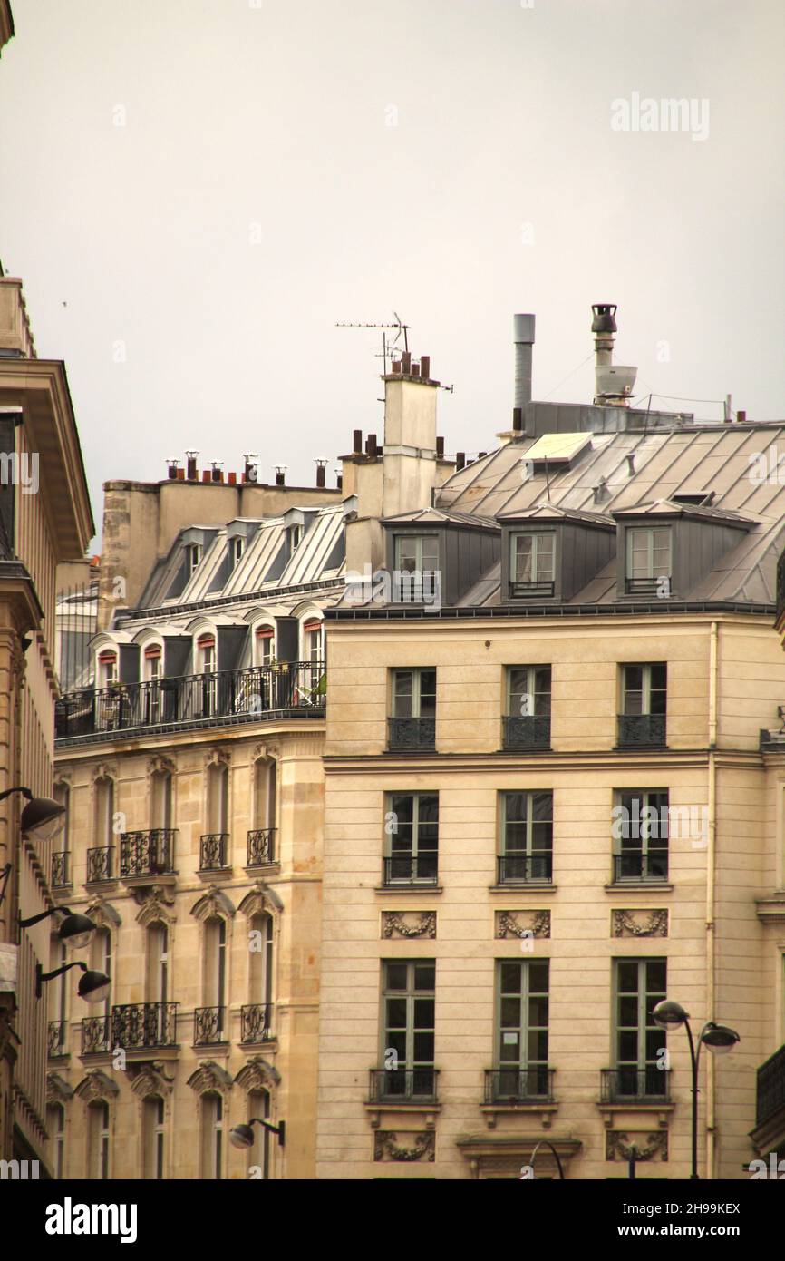 A vertical shot of the exterior of a building with windows in Paris ...