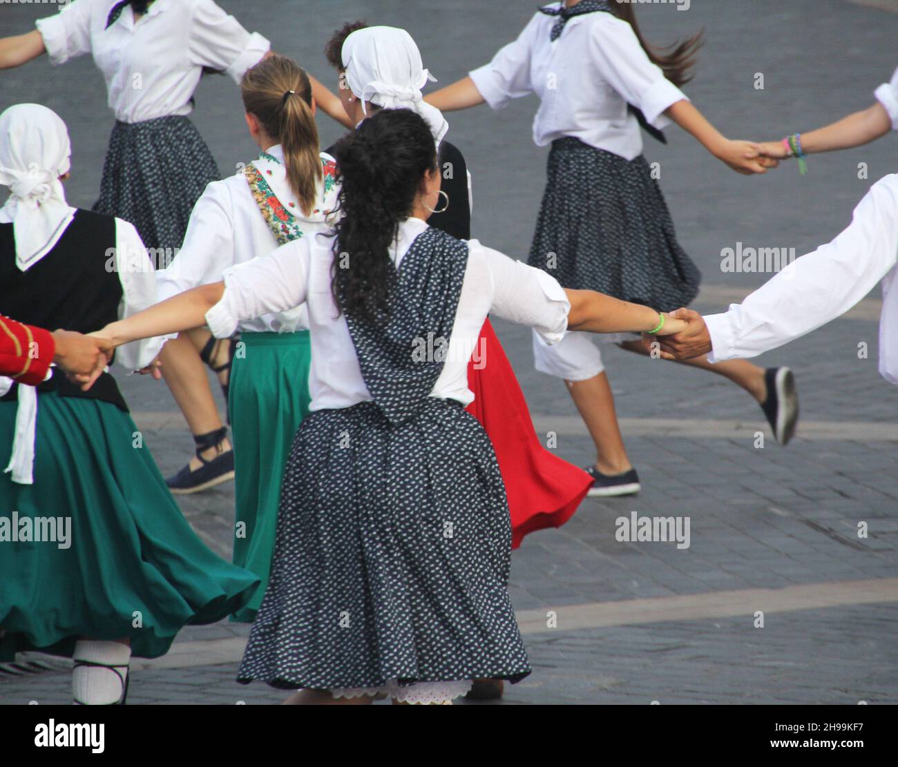 The folk dancers dancing with traditional costumes outside in Basque ...