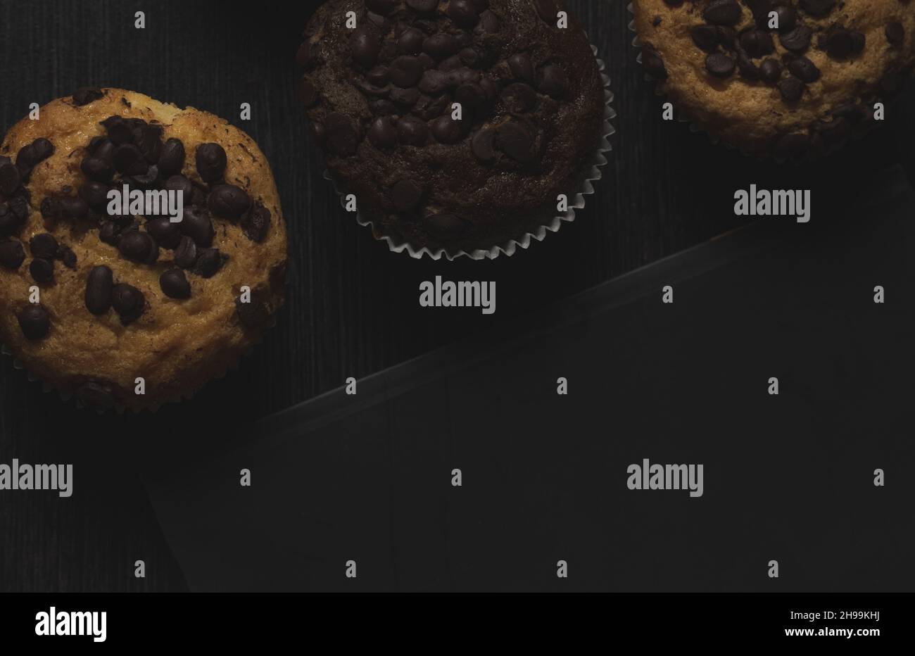 A closeup shot of delicious chocolate and vanilla muffins with ...