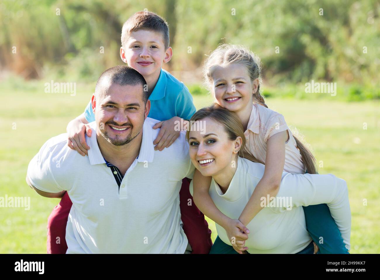 Joyful parents with children outdoor Stock Photo - Alamy