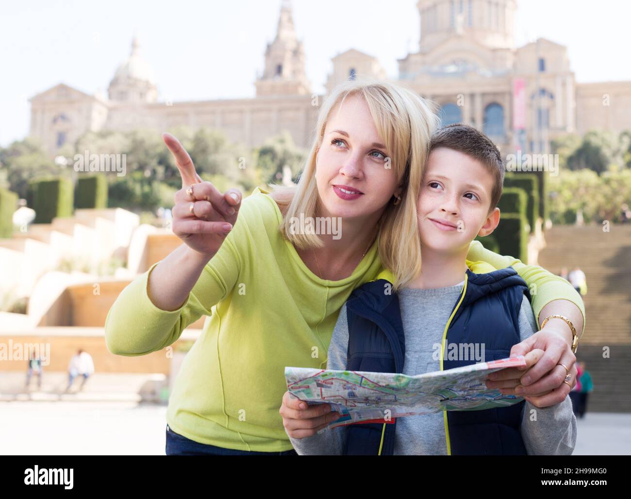 Mother and son reading map guide Stock Photo - Alamy