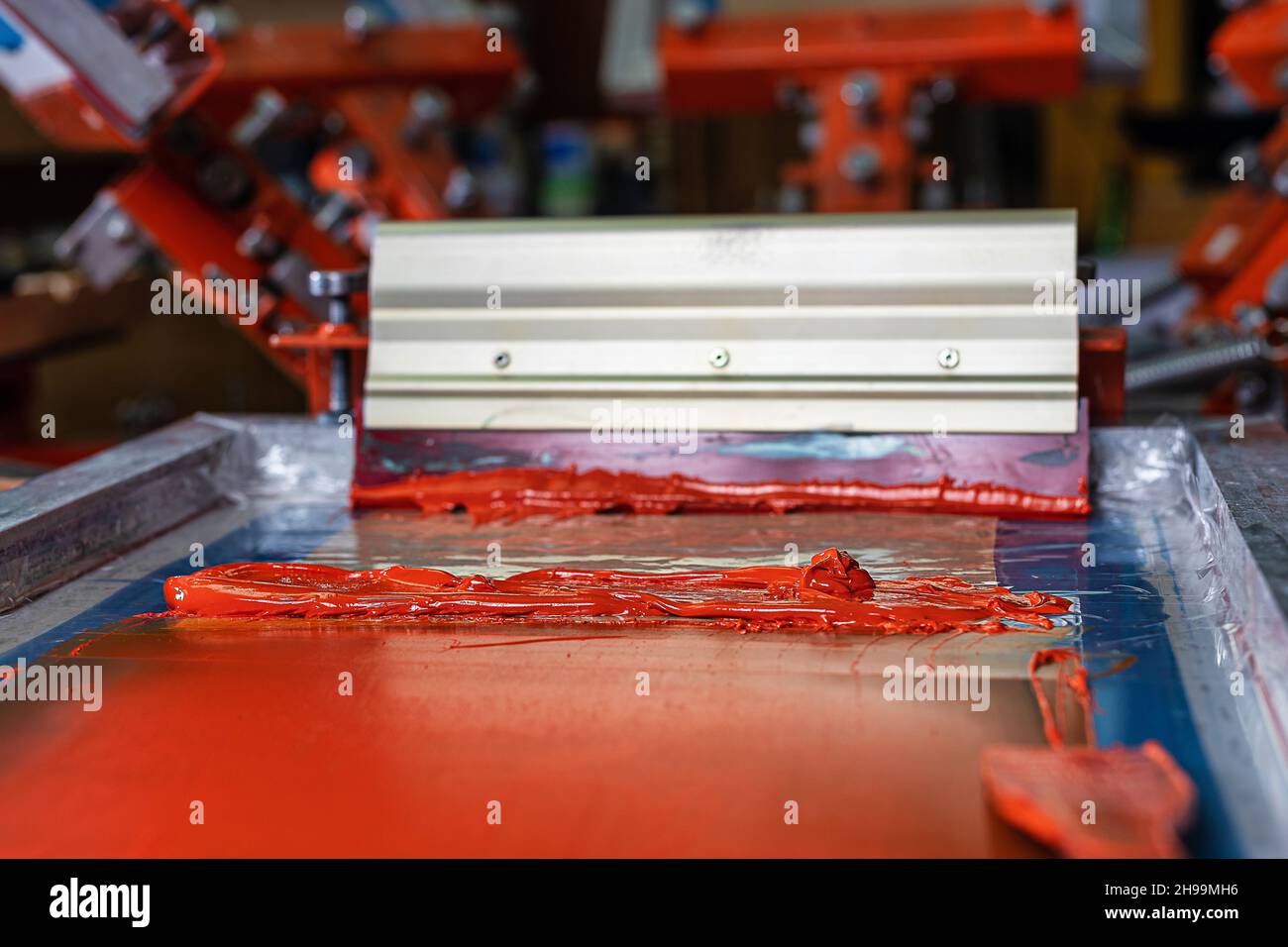 plastisol ink (paint) on a mesh screen frame. serigraphy production ...