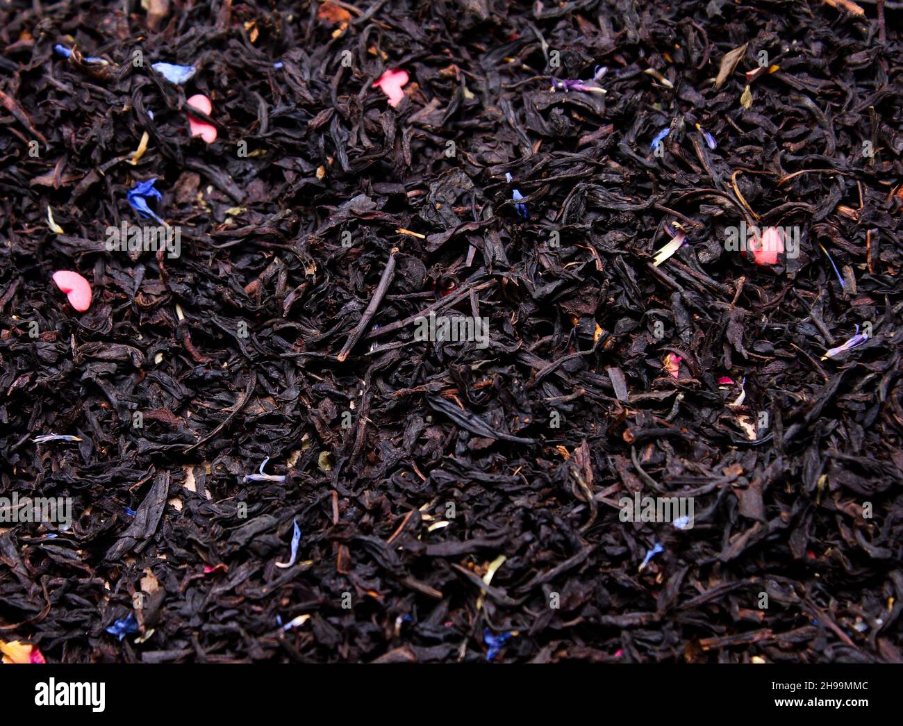black leaf tea with flower petals close-up, drink Stock Photo - Alamy