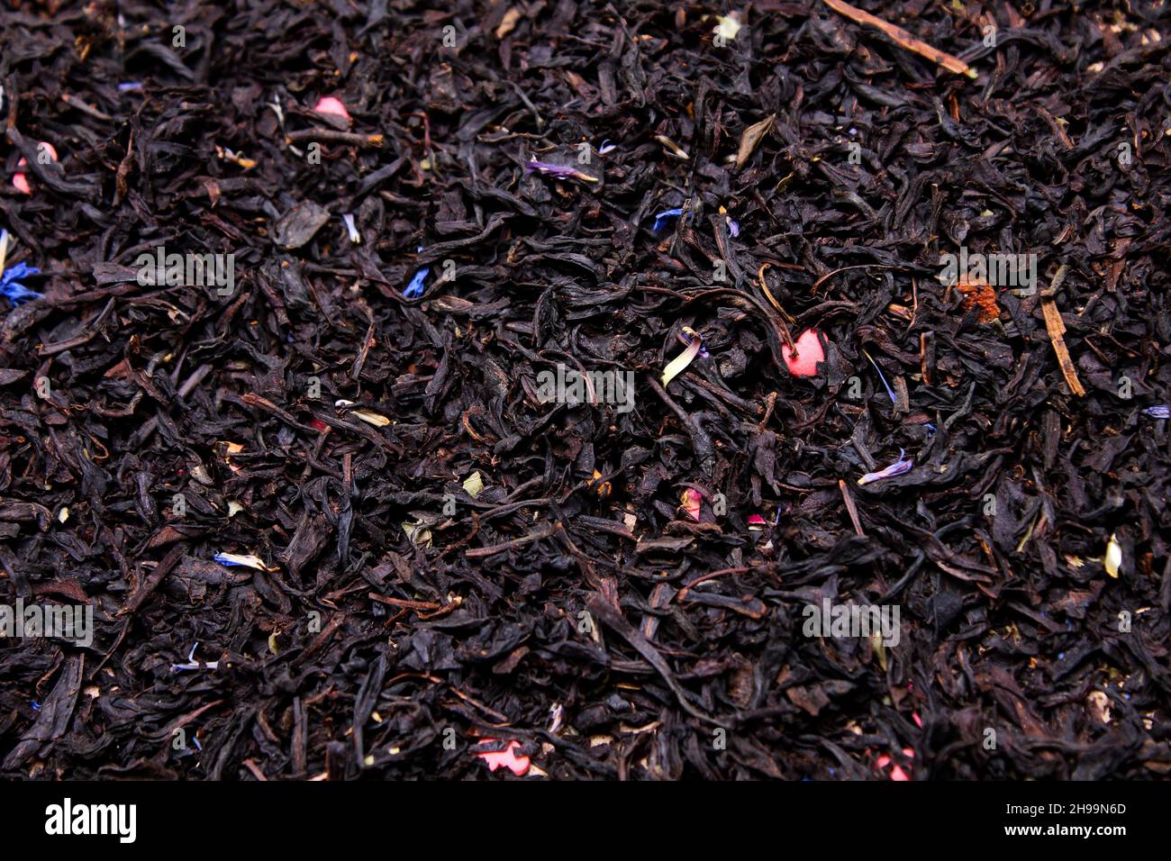 black leaf tea with flower petals close-up, drink Stock Photo - Alamy