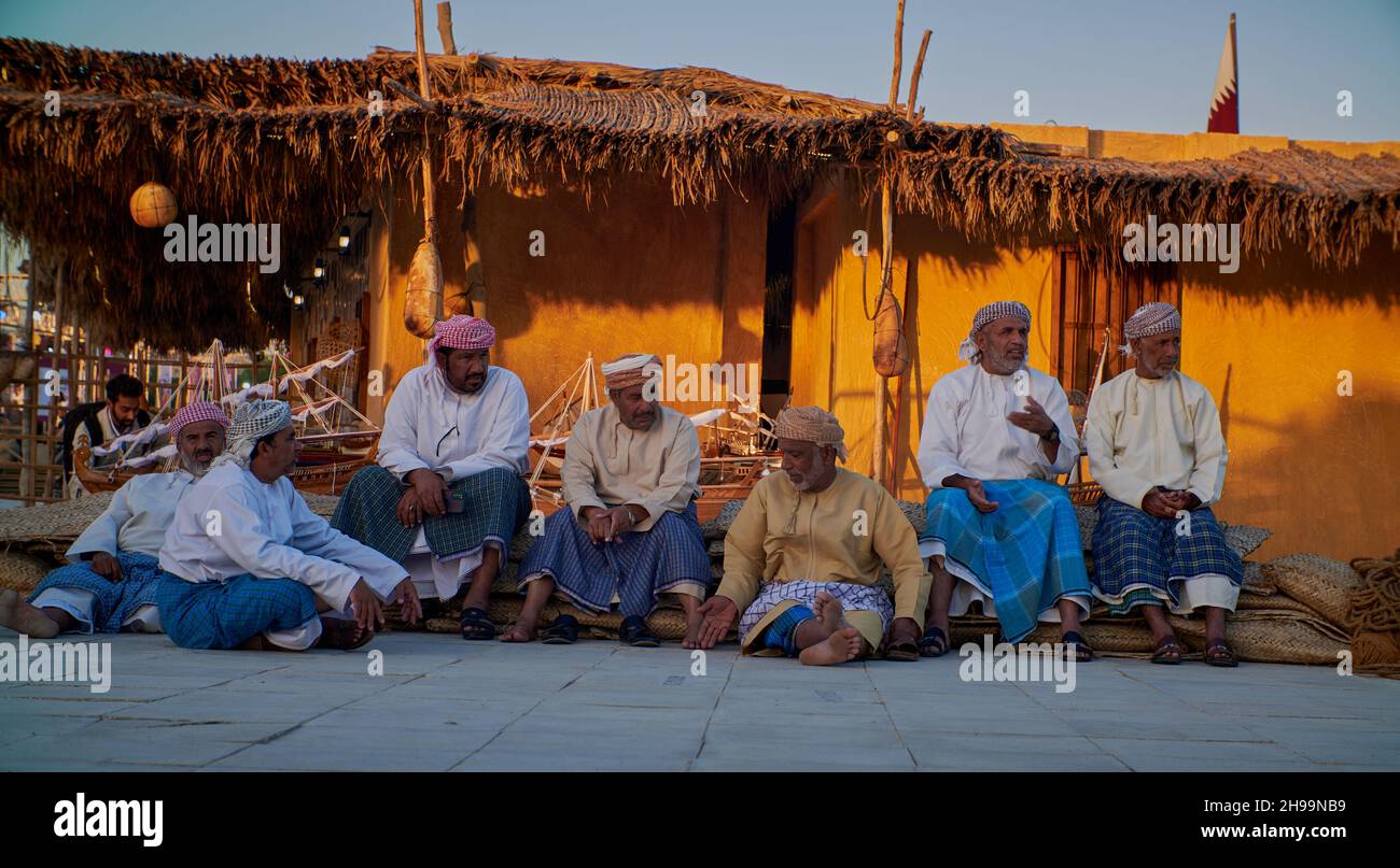 Group of Traditional Arabic fishermen sitting in Katara cultural ...