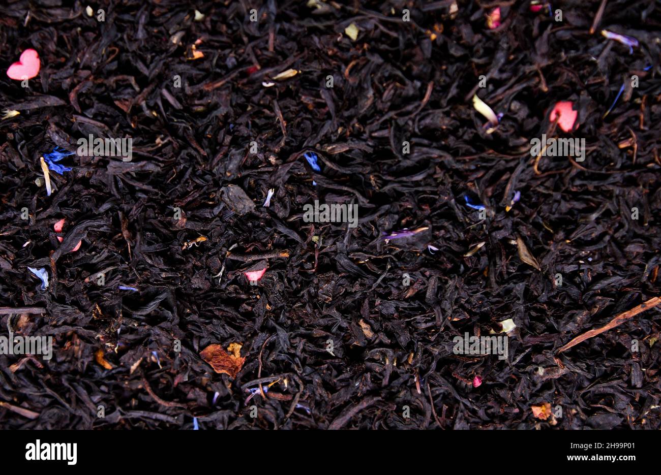 black leaf tea with flower petals close-up, drink Stock Photo - Alamy