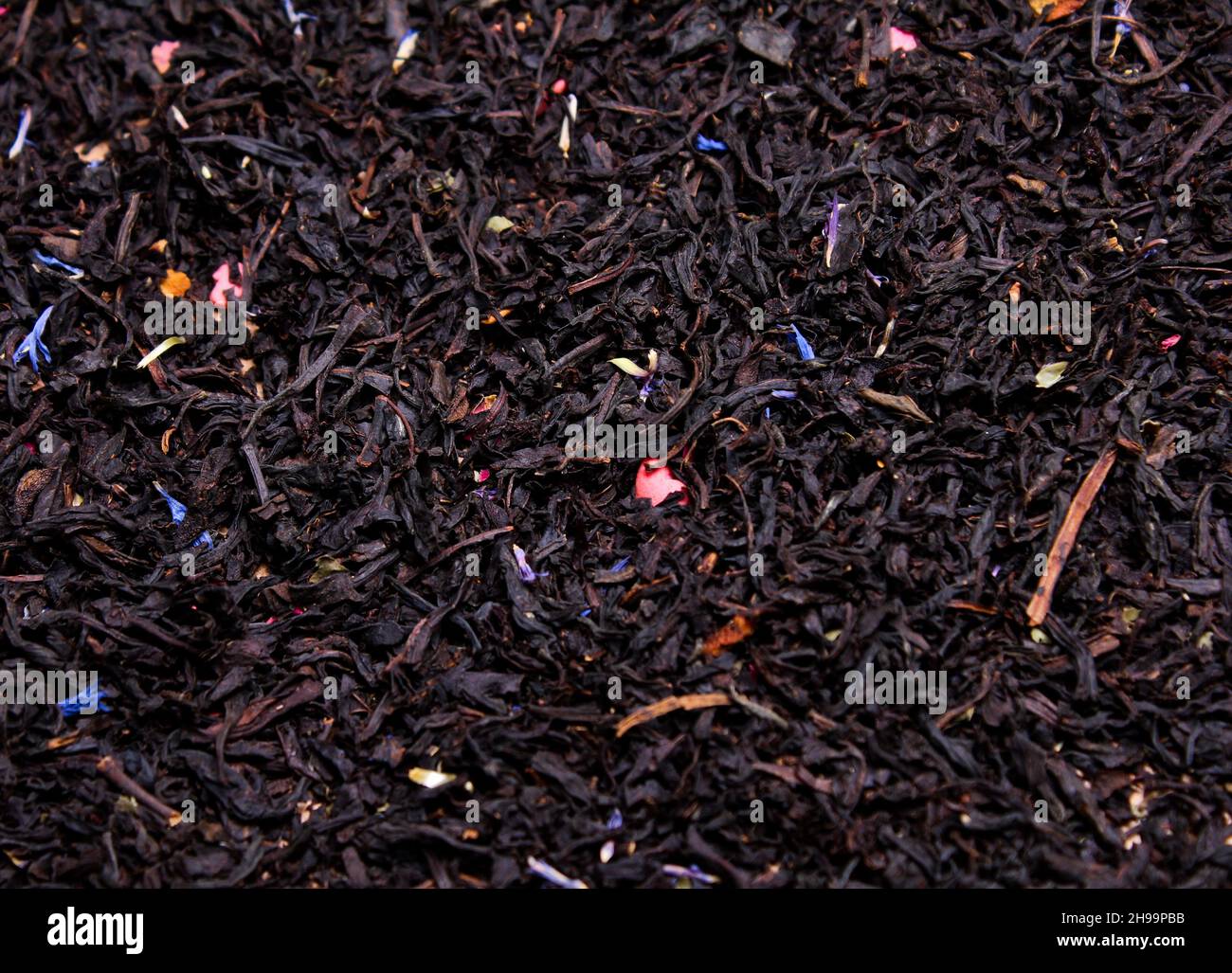 black leaf tea with flower petals close-up, drink Stock Photo - Alamy