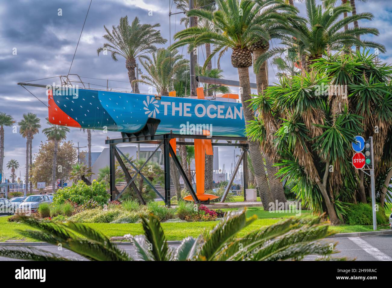 Ocean Race Sailboat monument on roundabout place with palms around ...