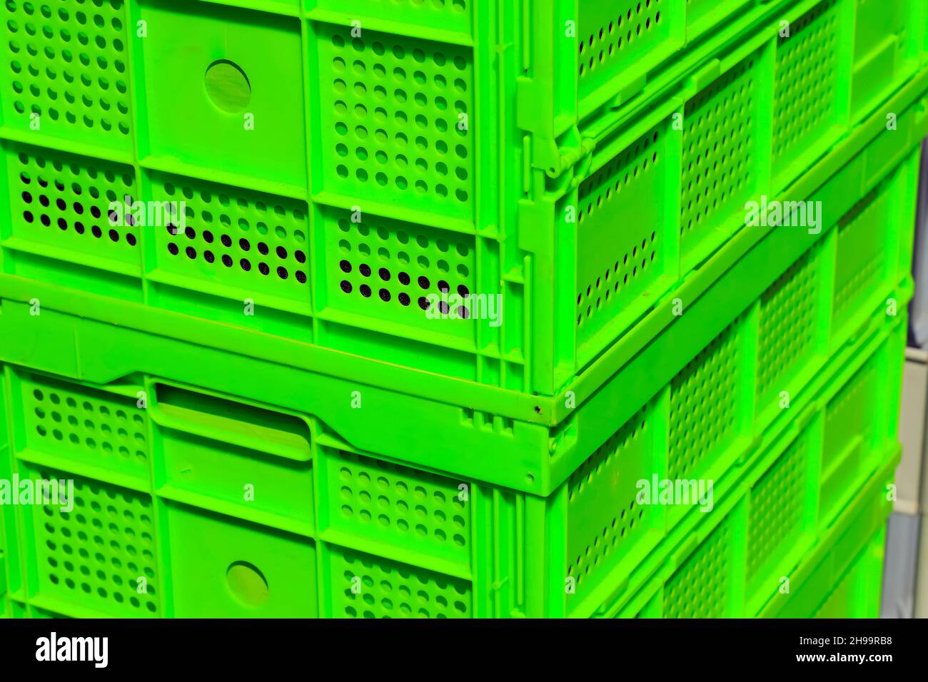 Two green plastic crates are placed one on top of the other Stock Photo ...