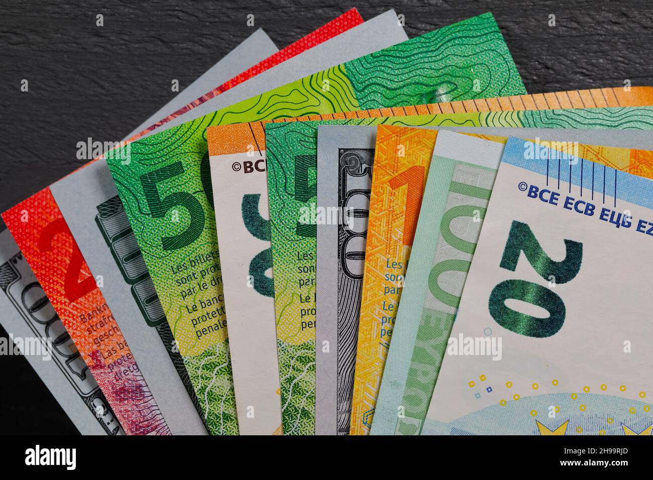 A variety of paper money forms the financial backdrop. There are ...