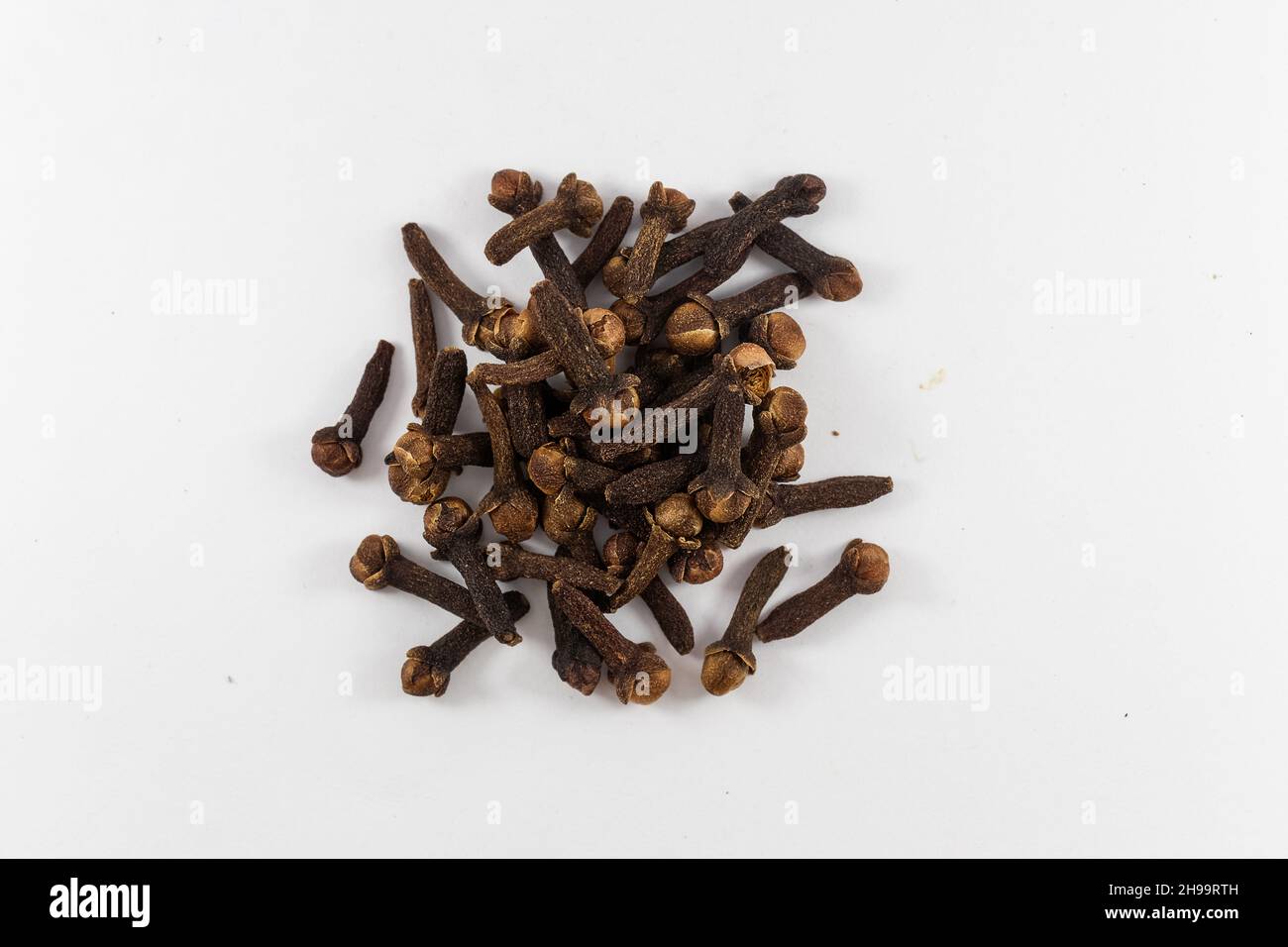 A pile of organic fresh whole clove buds isolated on white background ...
