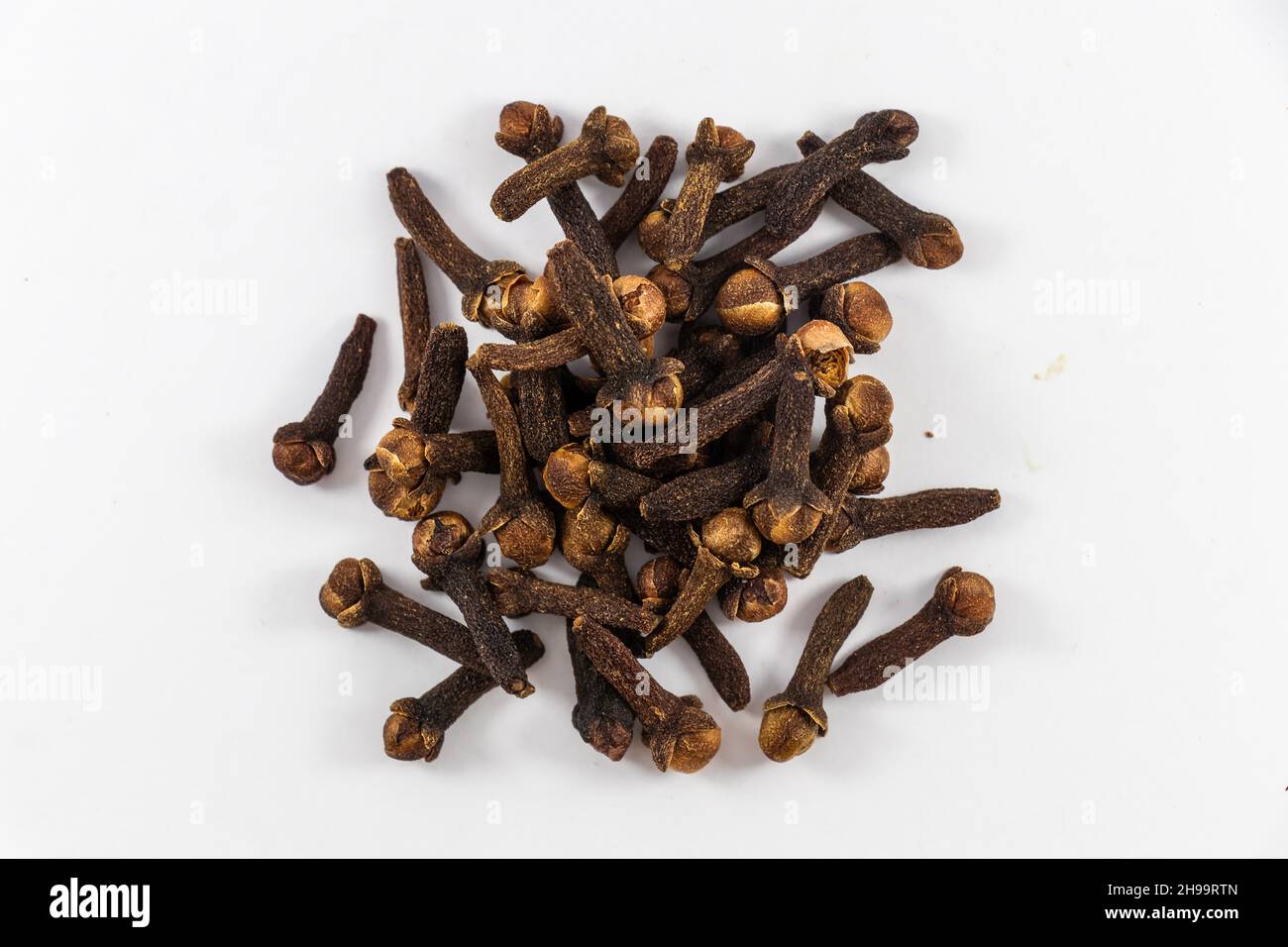 A pile of organic fresh whole clove buds isolated on white background ...