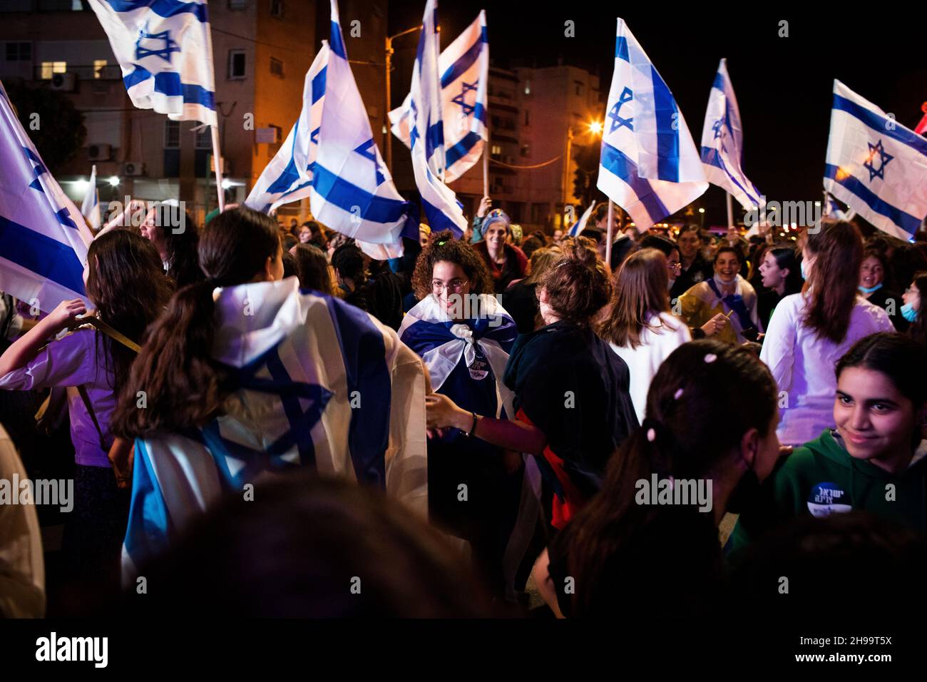 Lod, Israel. 05th Dec, 2021. Right-wing protesters hold Israeli flags ...