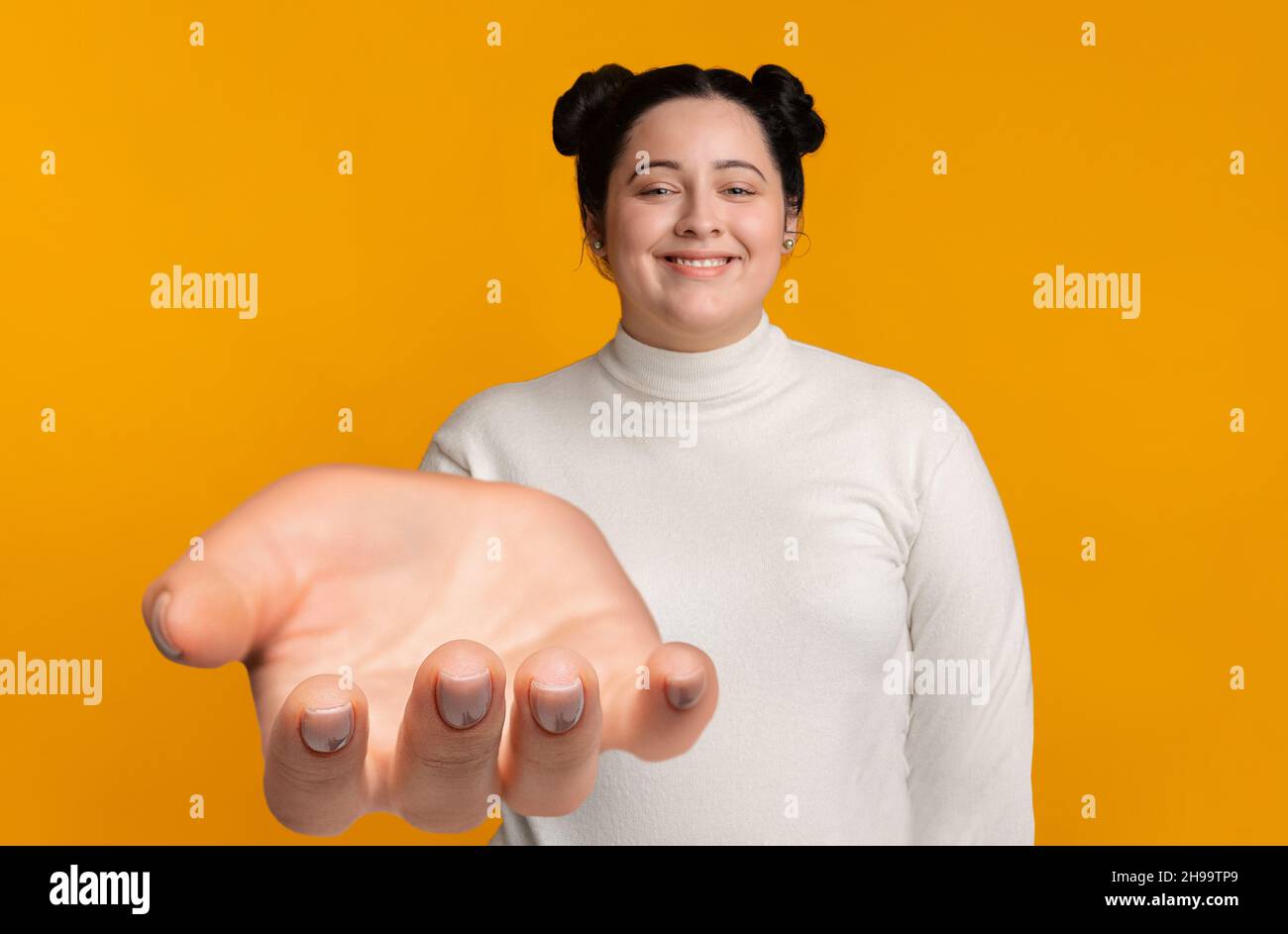 Happy plus size woman stretching open palm with mockup for product ...
