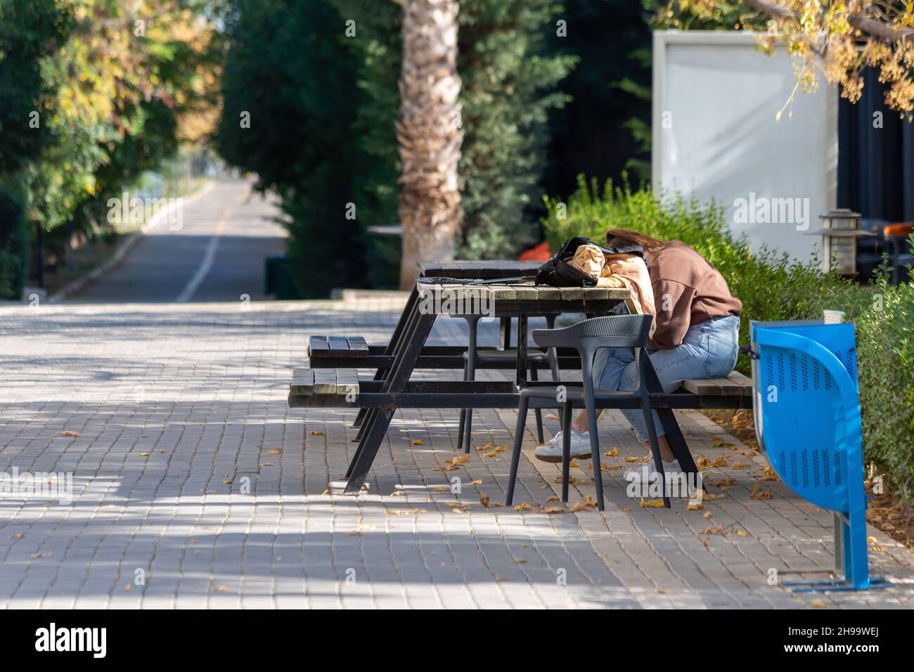 A student falling asleep in the schoolyard after class Stock Photo - Alamy
