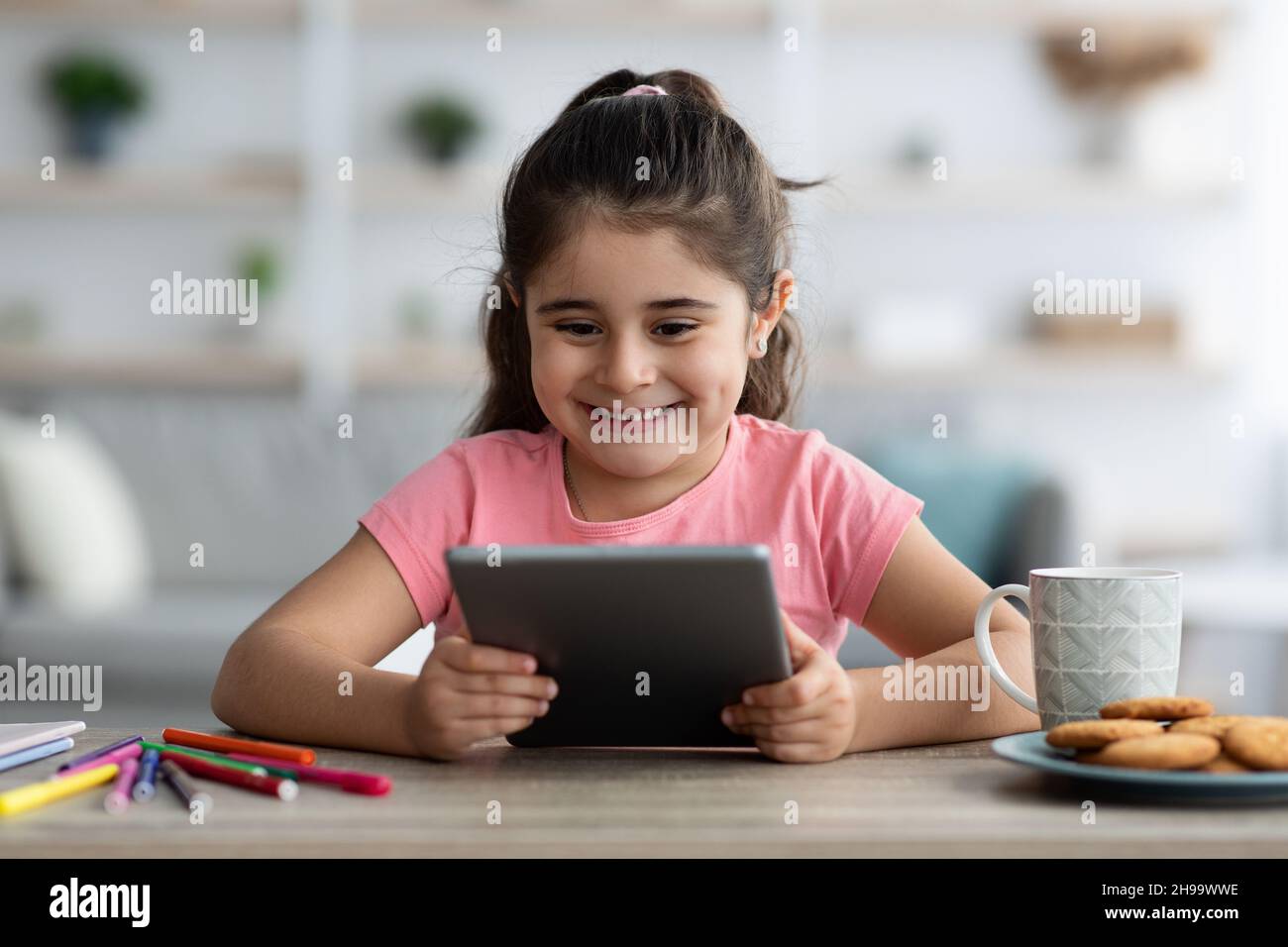 Gadgets For Kids. Happy Little Girl Relaxing With Digital Tablet At ...