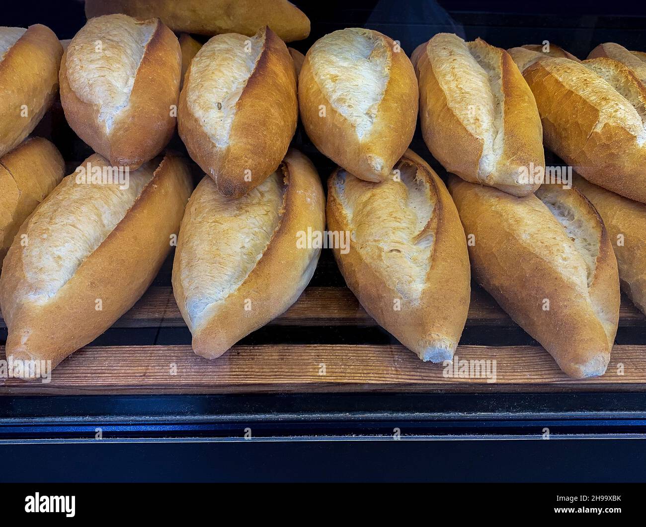 Loaves of bread lined up on the counter Stock Photo - Alamy