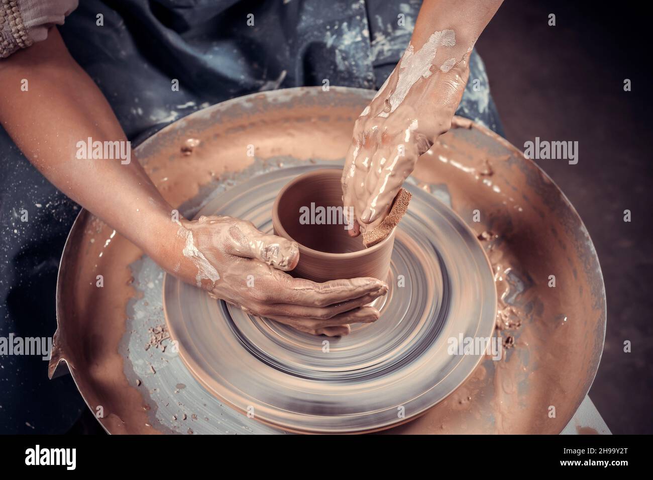 hands of potter do a clay pot Stock Photo - Alamy