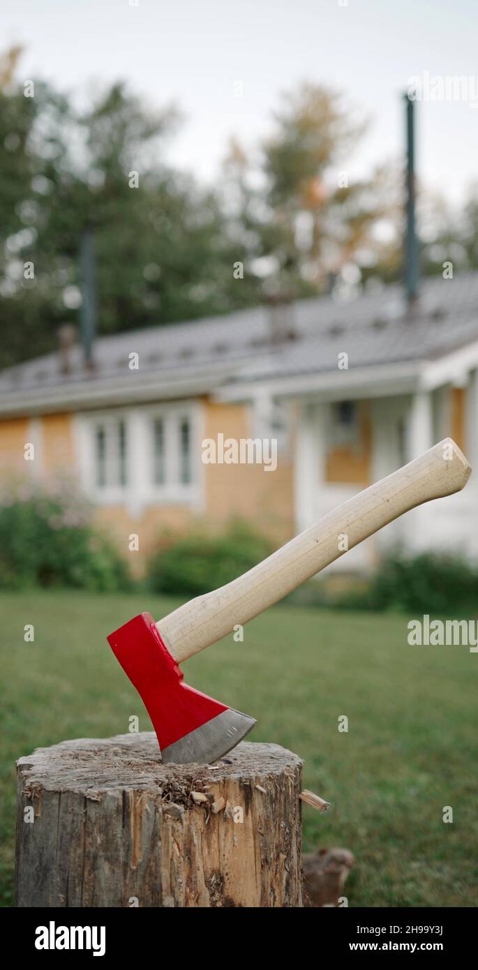 A vertical photo of an axe in garden Stock Photo - Alamy