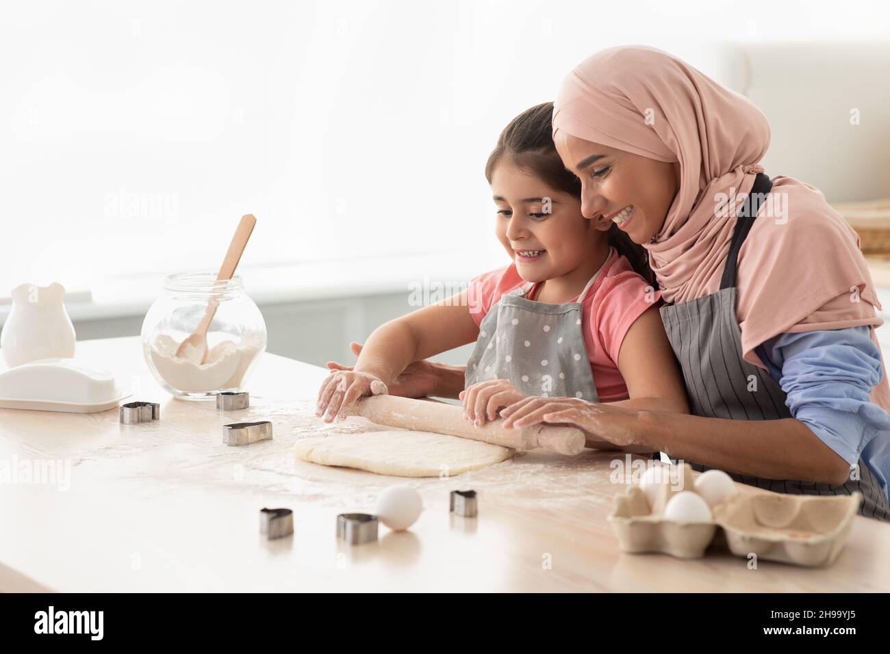 Caring Muslim Mom Teaching Her Little Daughter How To Roll Dough Stock ...