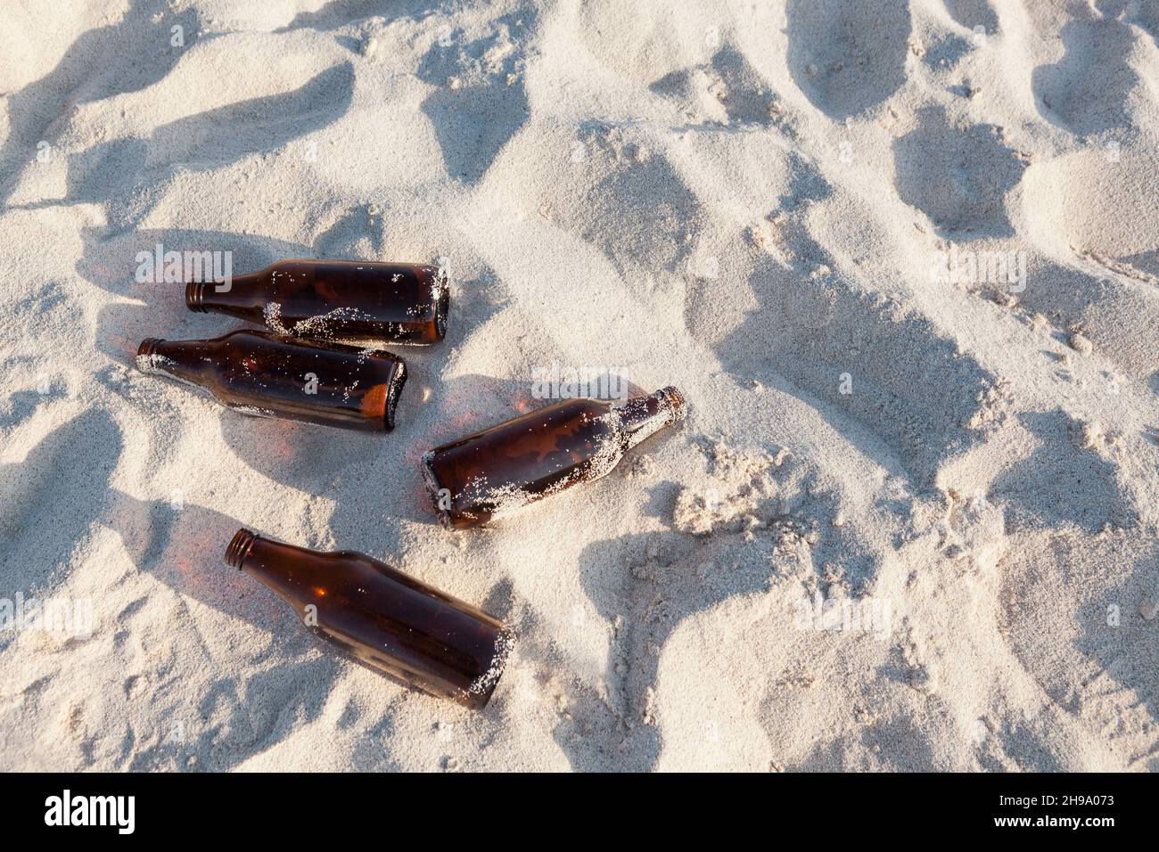 Empty abandoned beer bottles on beach Stock Photo - Alamy