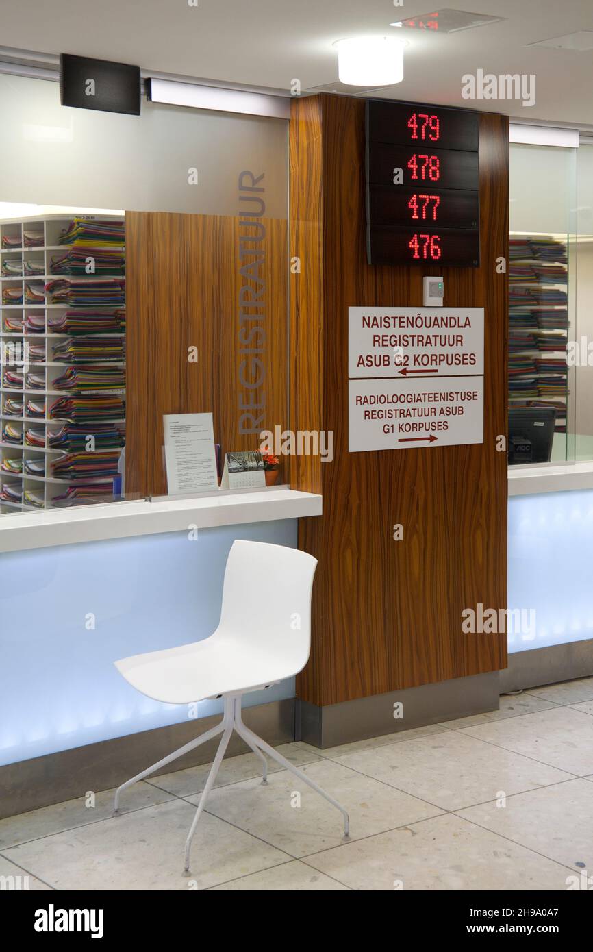 Waiting area and reception desk at a modern hospital, with signs and ...