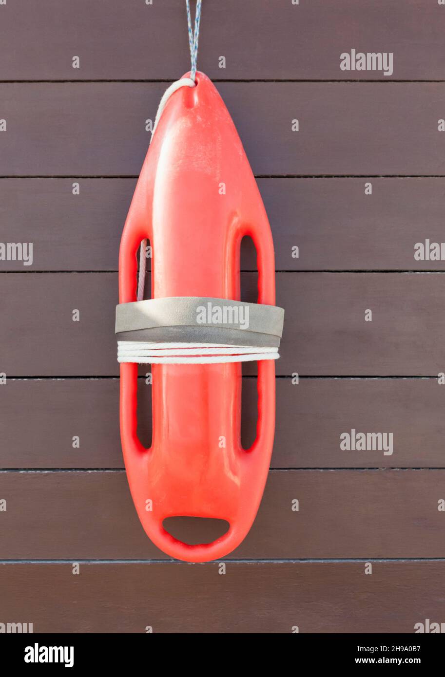 Orange lifeguard buoy, a safety float hanging on a wood wall Stock ...
