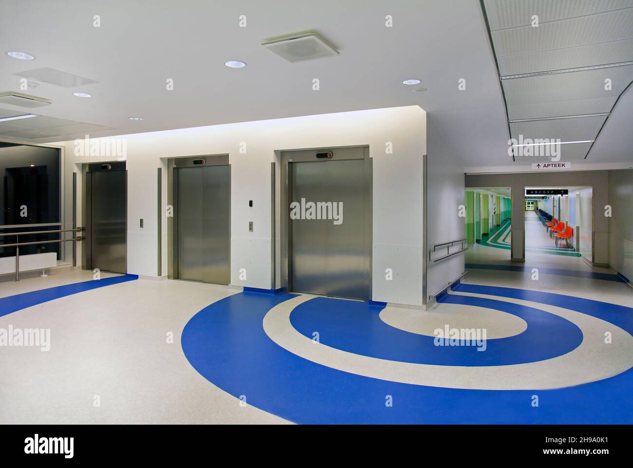 Elevators in the atrium of a new modern hospital, blue patterns on the ...