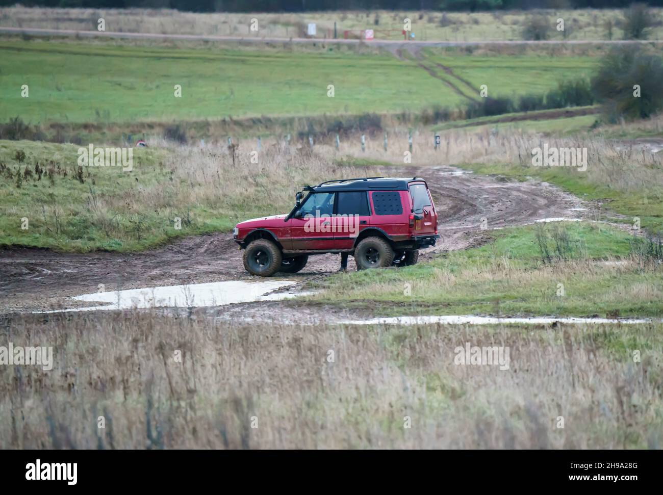 Land Rover Discovery II 2 4x4 off-road vehicle driving across mud and ...
