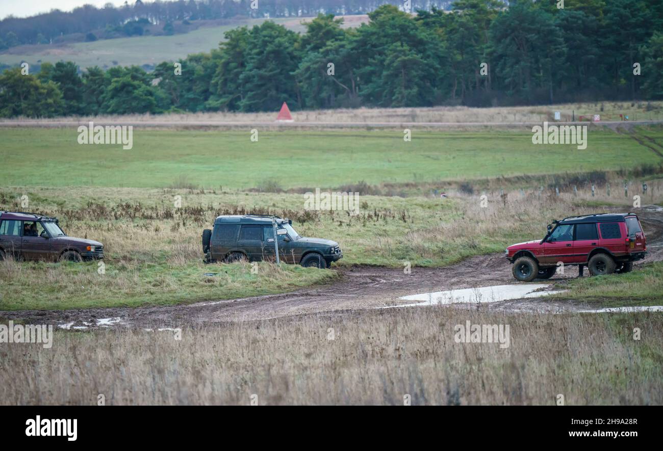 4x4 off-road vehicles driving across mud and water-logged terrain ...