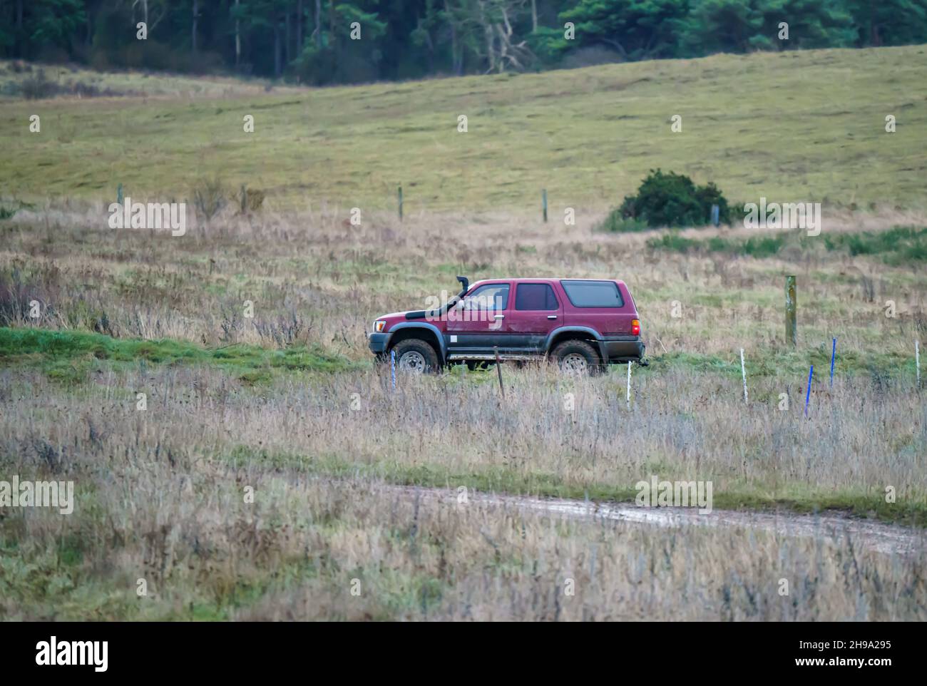 4x4 off-road vehicles driving across mud and water-logged terrain ...