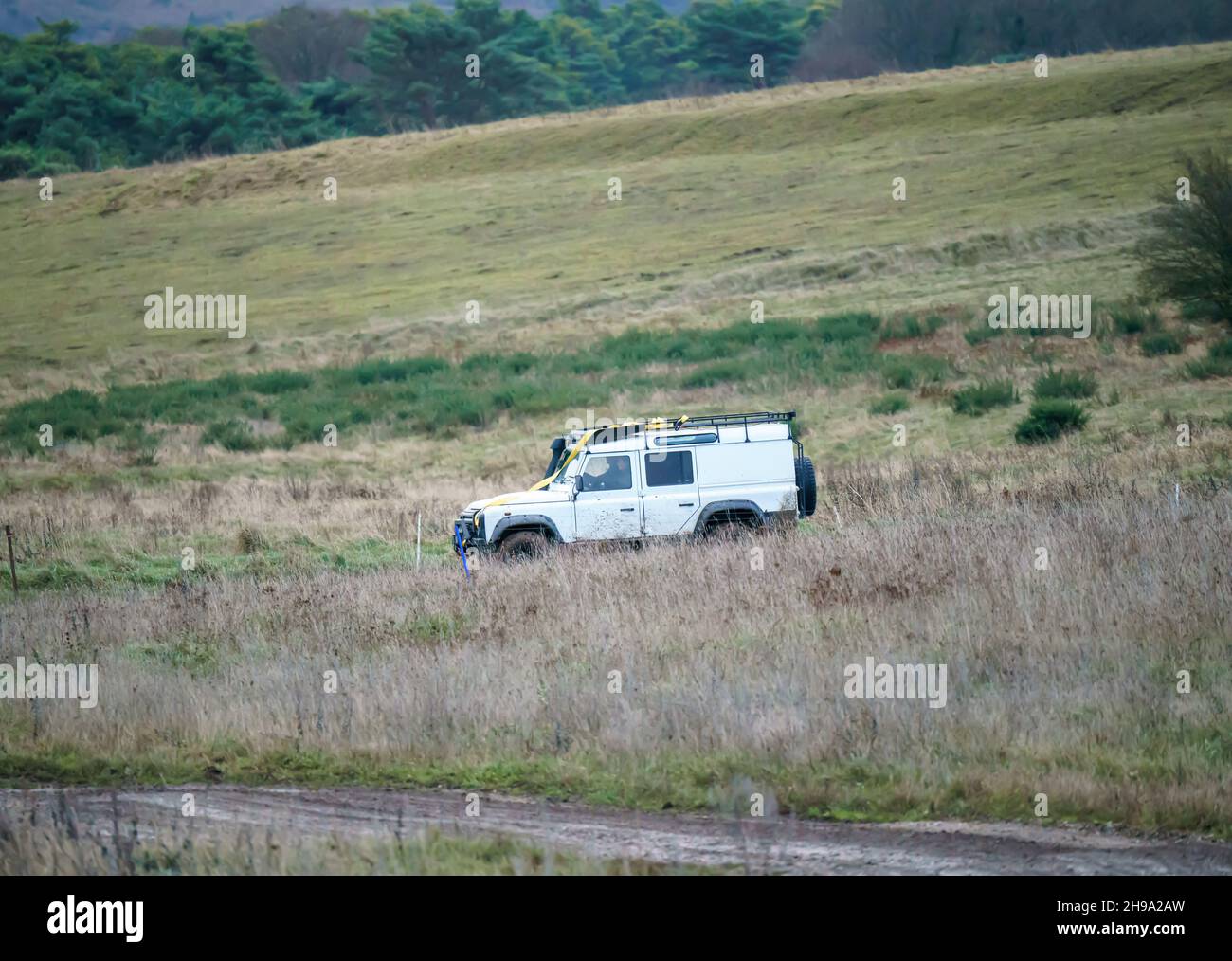 4x4 off-road vehicle driving across mud and water-logged terrain ...