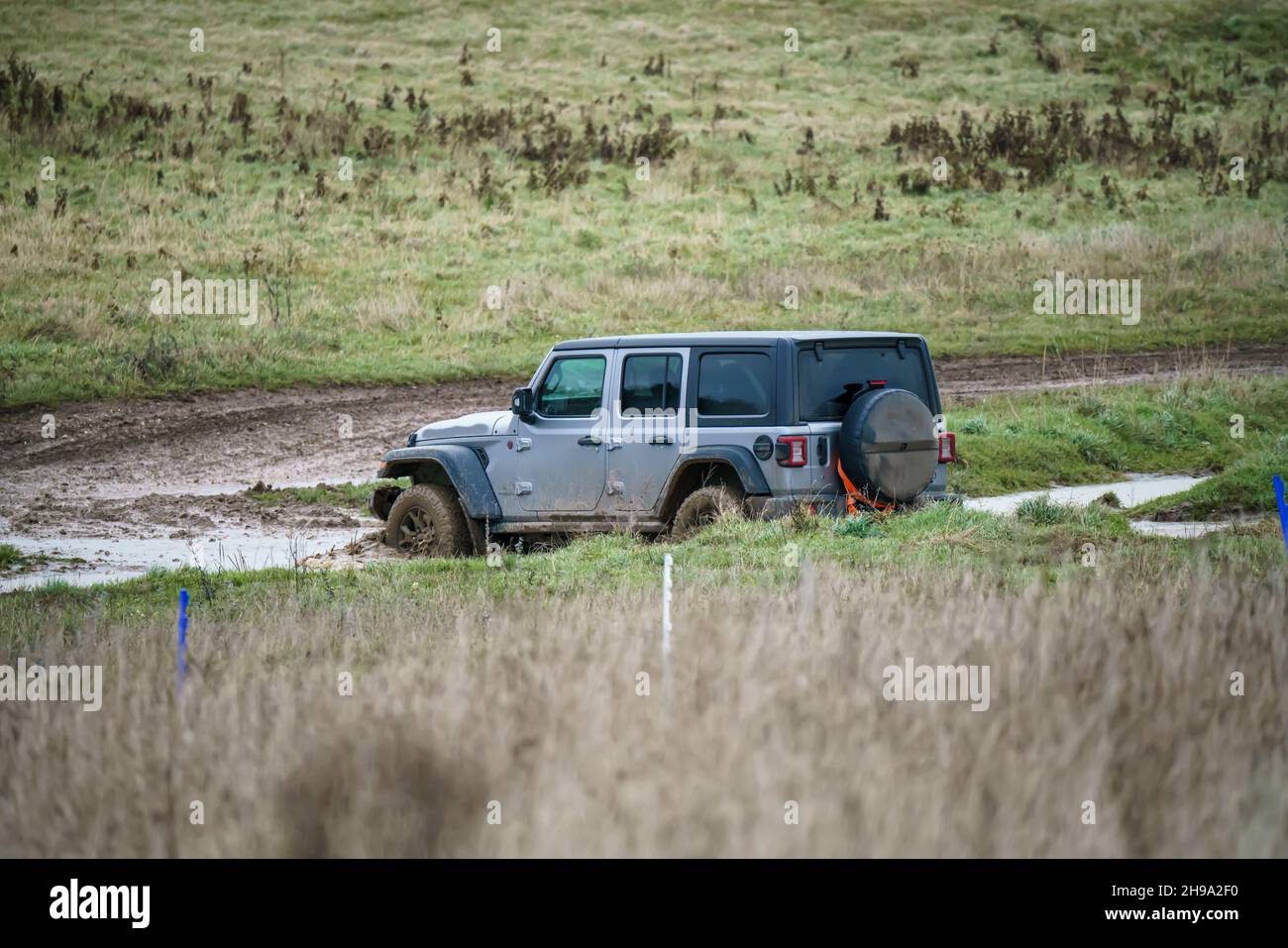 4x4 off-road vehicles driving across mud and water-logged terrain ...