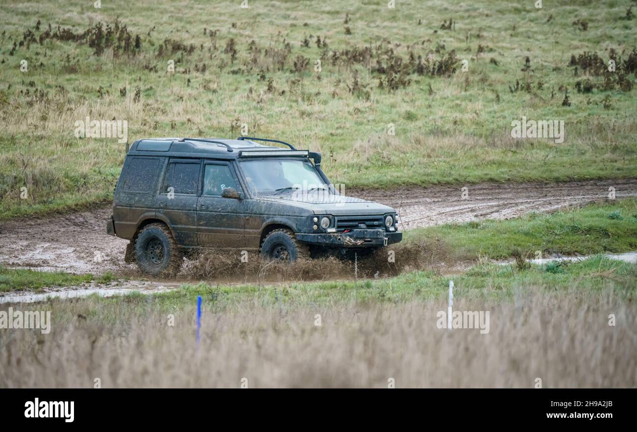 Land Rover Discovery II 2 4x4 off-road vehicle driving across mud and ...