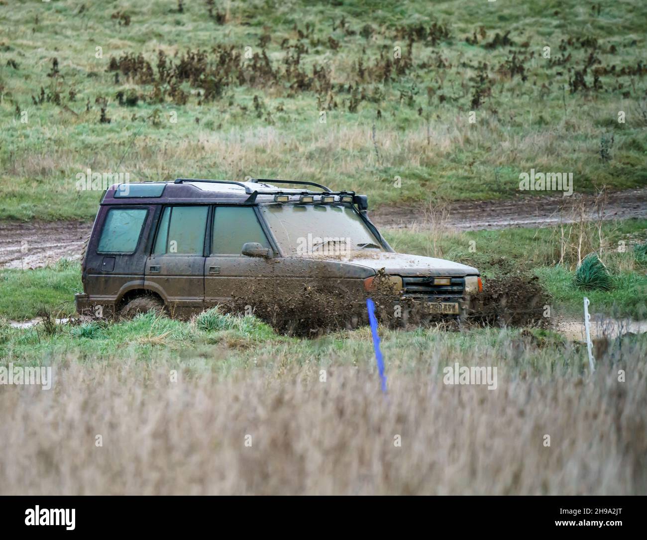 Land Rover Discovery II 2 4x4 off-road vehicle driving across mud and ...