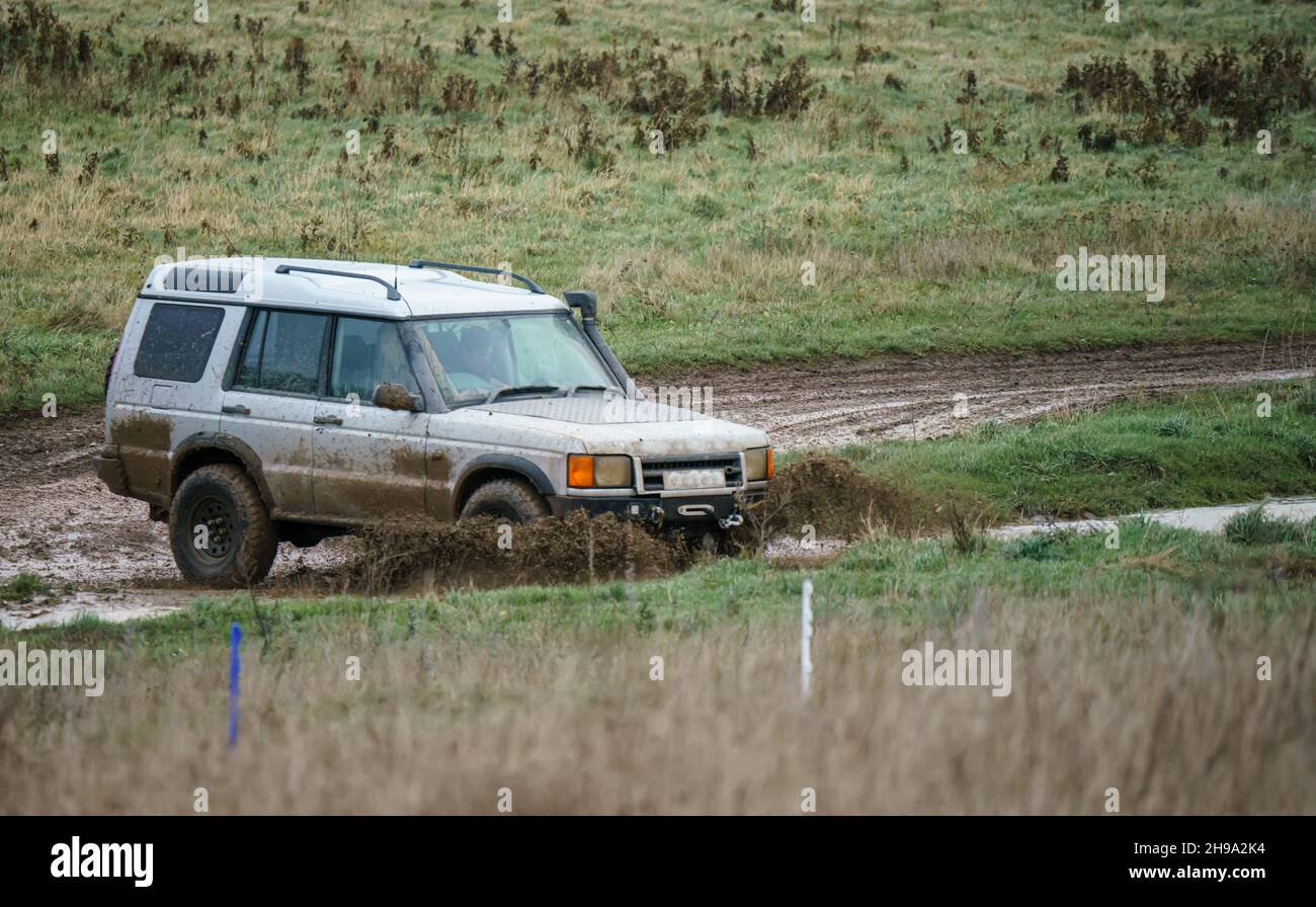 Land Rover Discovery II 2 4x4 off-road vehicle driving across mud and ...