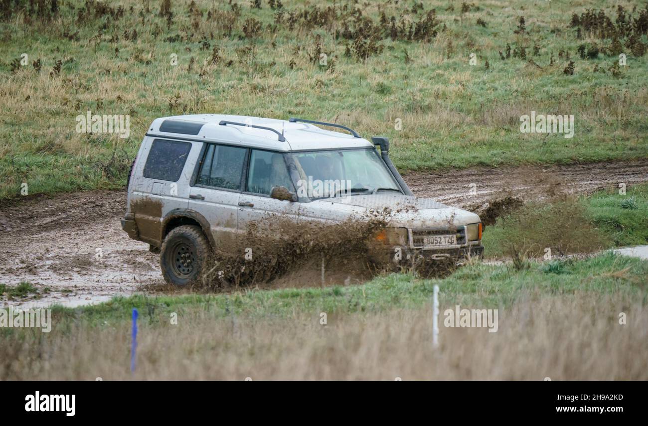 Land Rover Discovery II 2 4x4 off-road vehicle driving across mud and ...